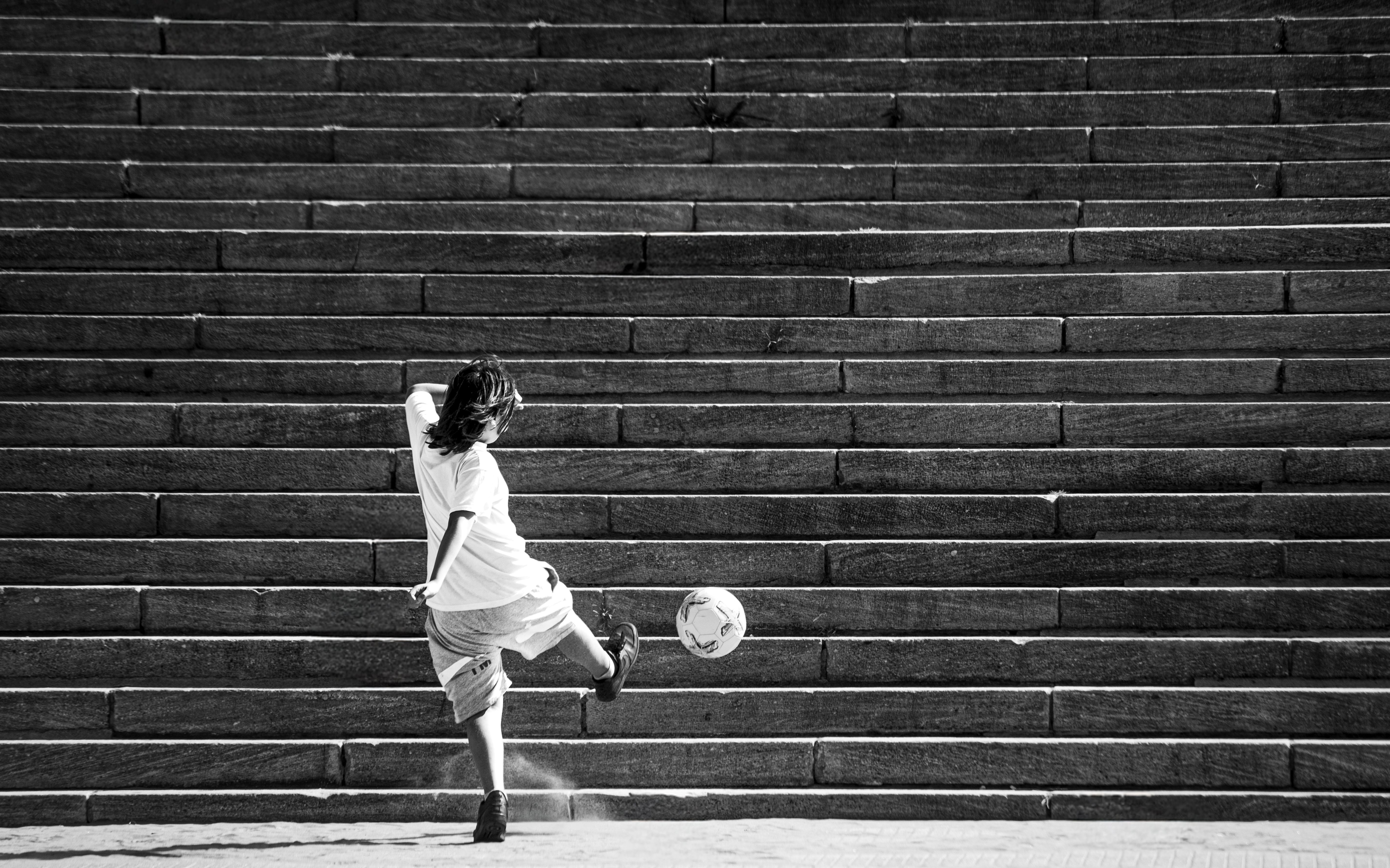 Child Playing Soccer on Stone Steps in Argentina · Free Stock Photo