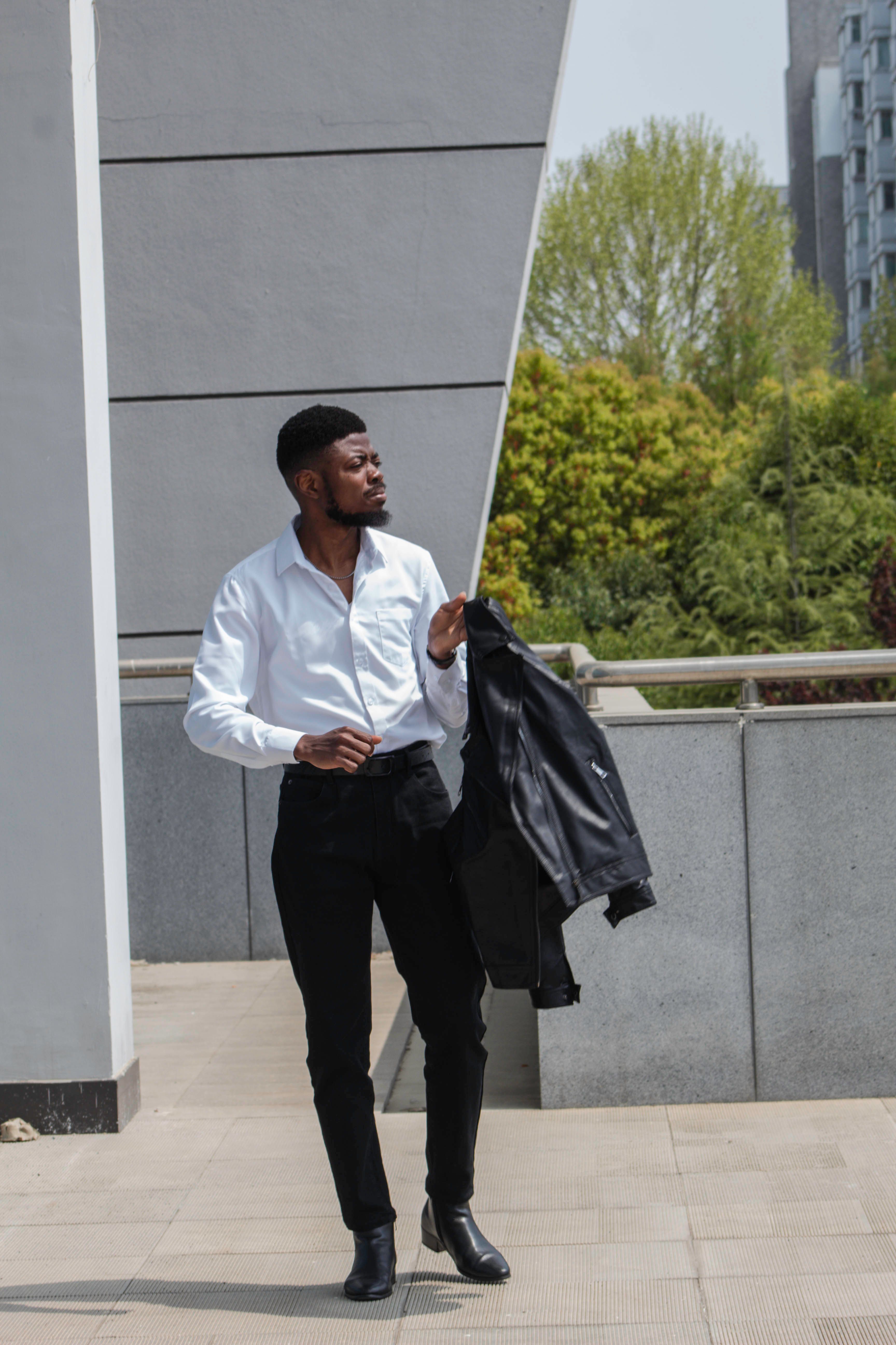 Stylish Man Walking Outdoors in Urban Setting · Free Stock Photo