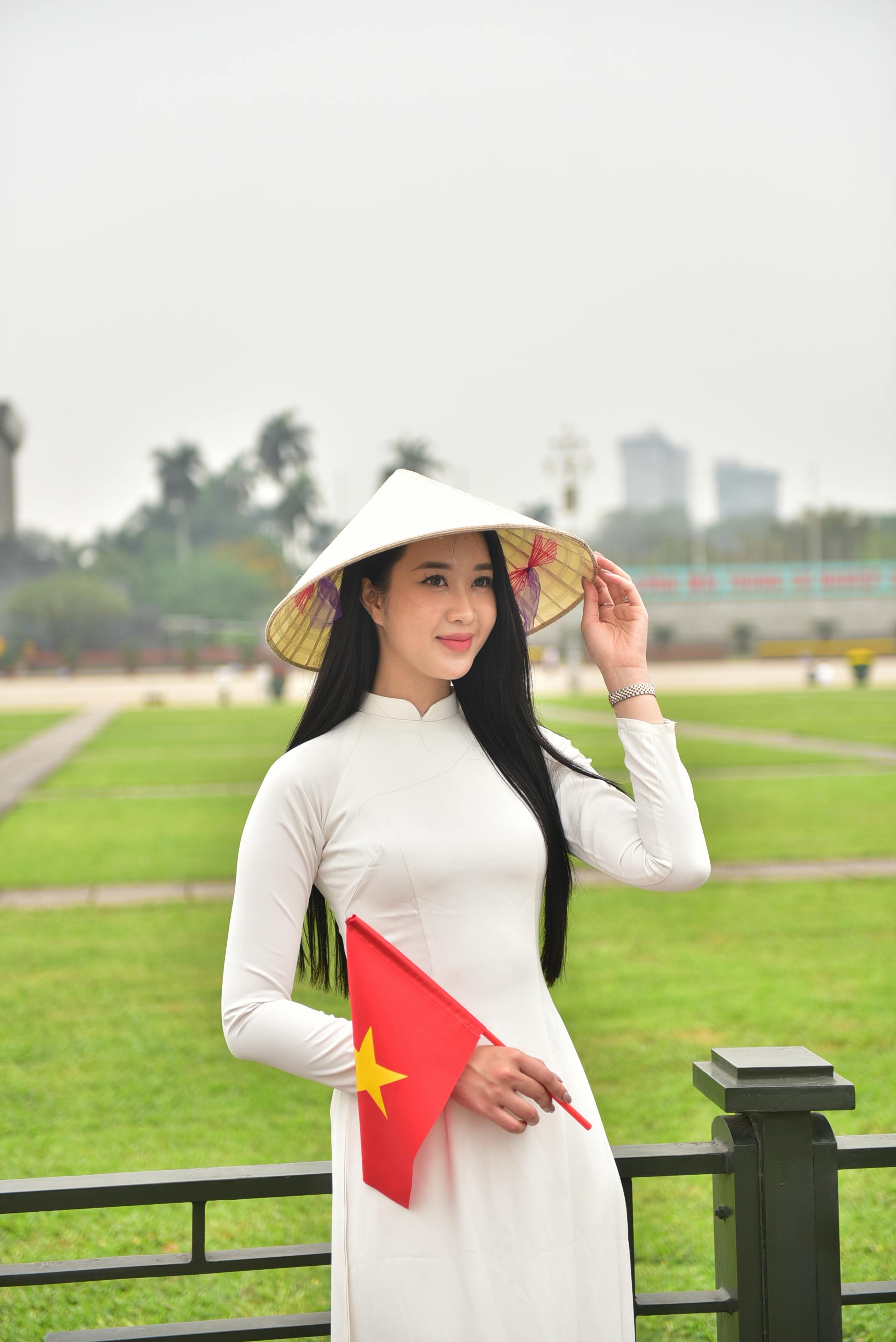 Vietnamese Woman Holding Flag in Traditional Ao Dai · Free Stock Photo