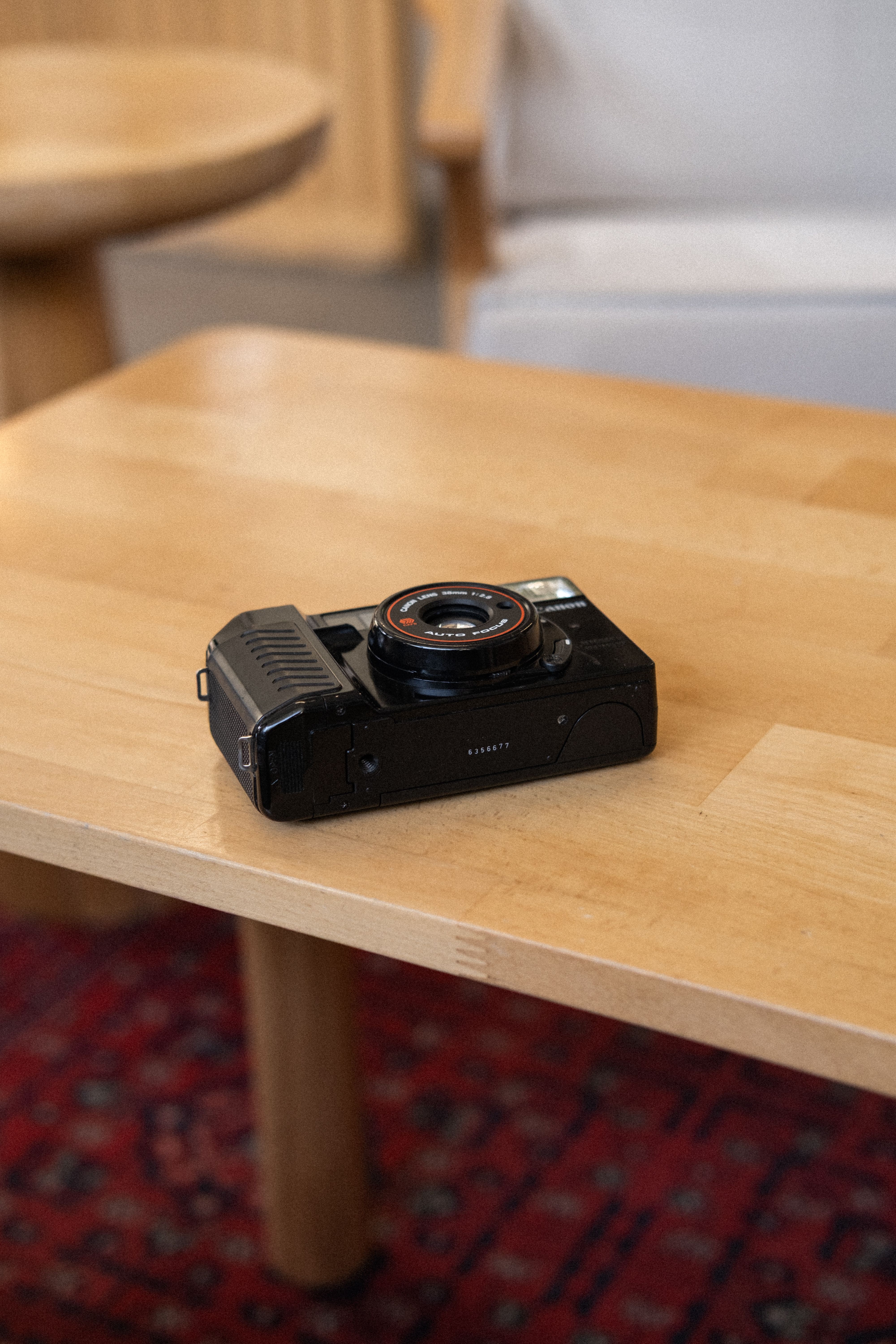 Vintage Analog Camera on Wooden Table · Free Stock Photo