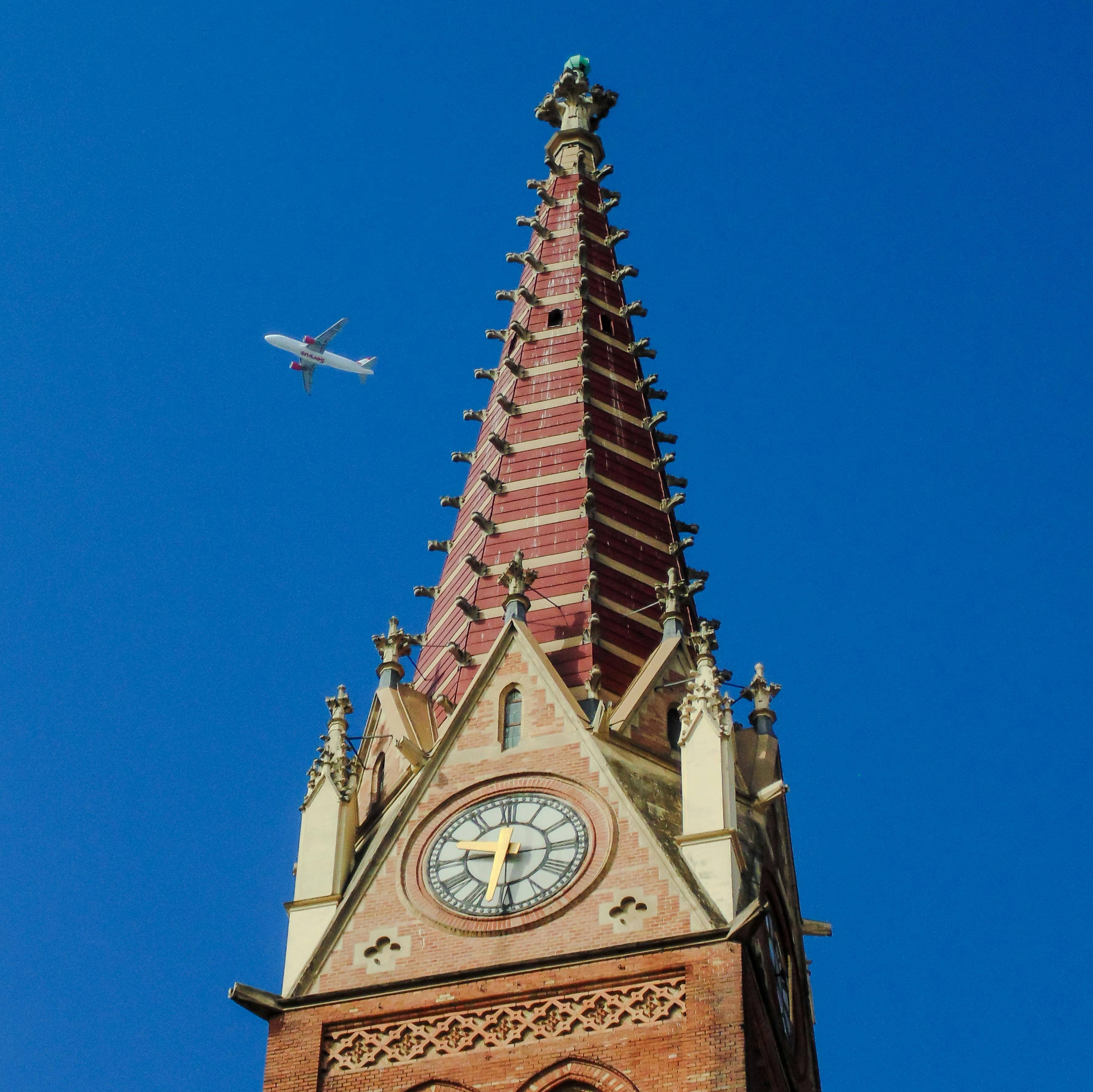 Gothic Church Spire with Airplane in Vienna · Free Stock Photo