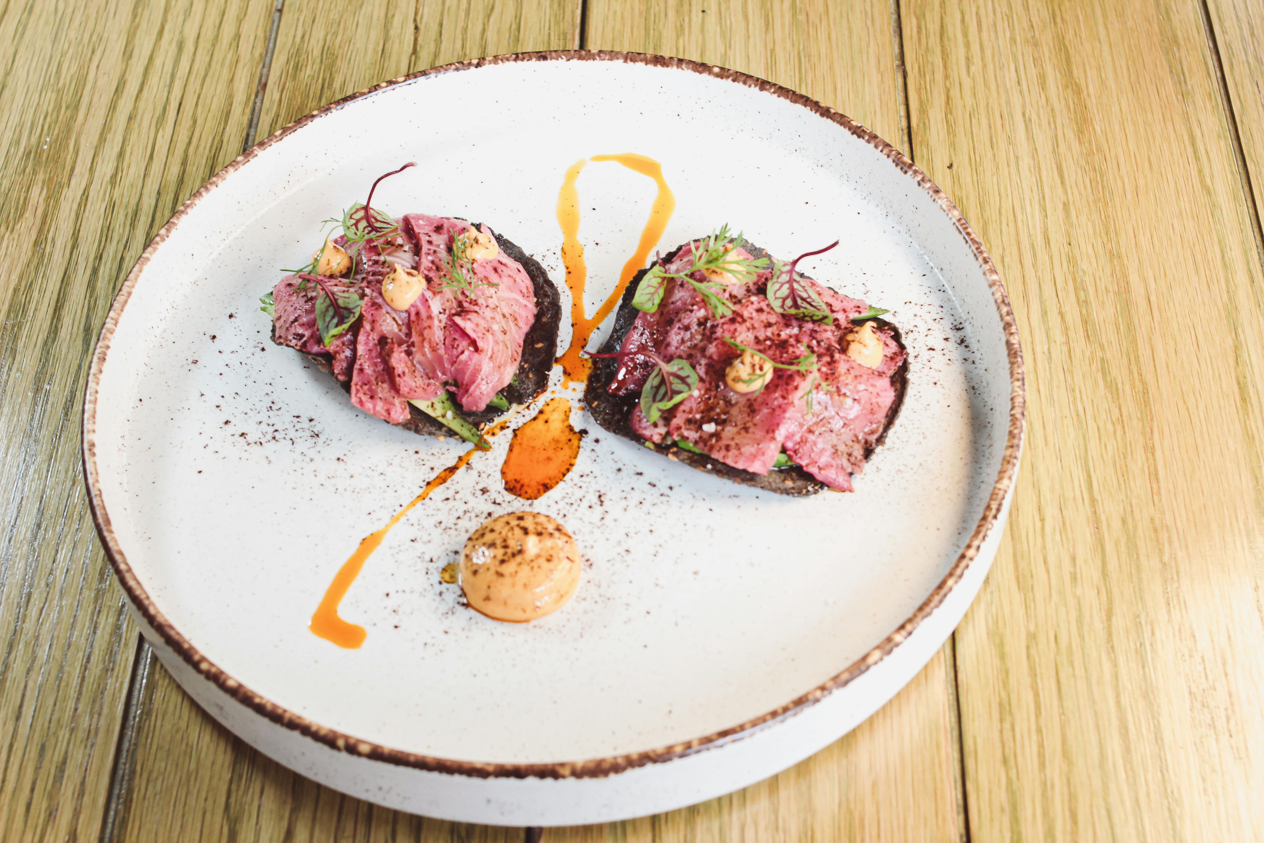 Elegant Beef Appetizer on Rustic Plate · Free Stock Photo