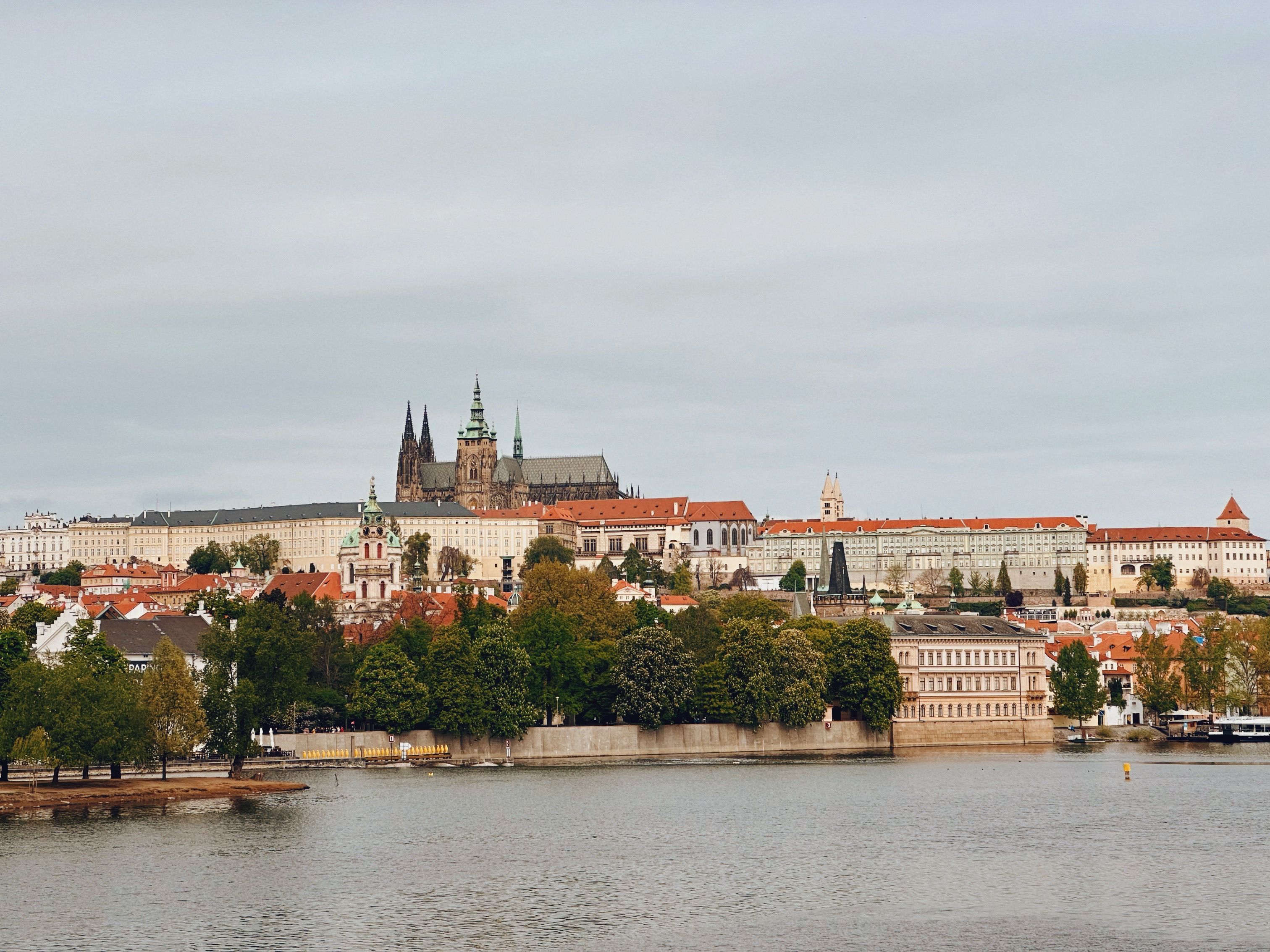 Scenic View of Prague Castle from Riverbank · Free Stock Photo