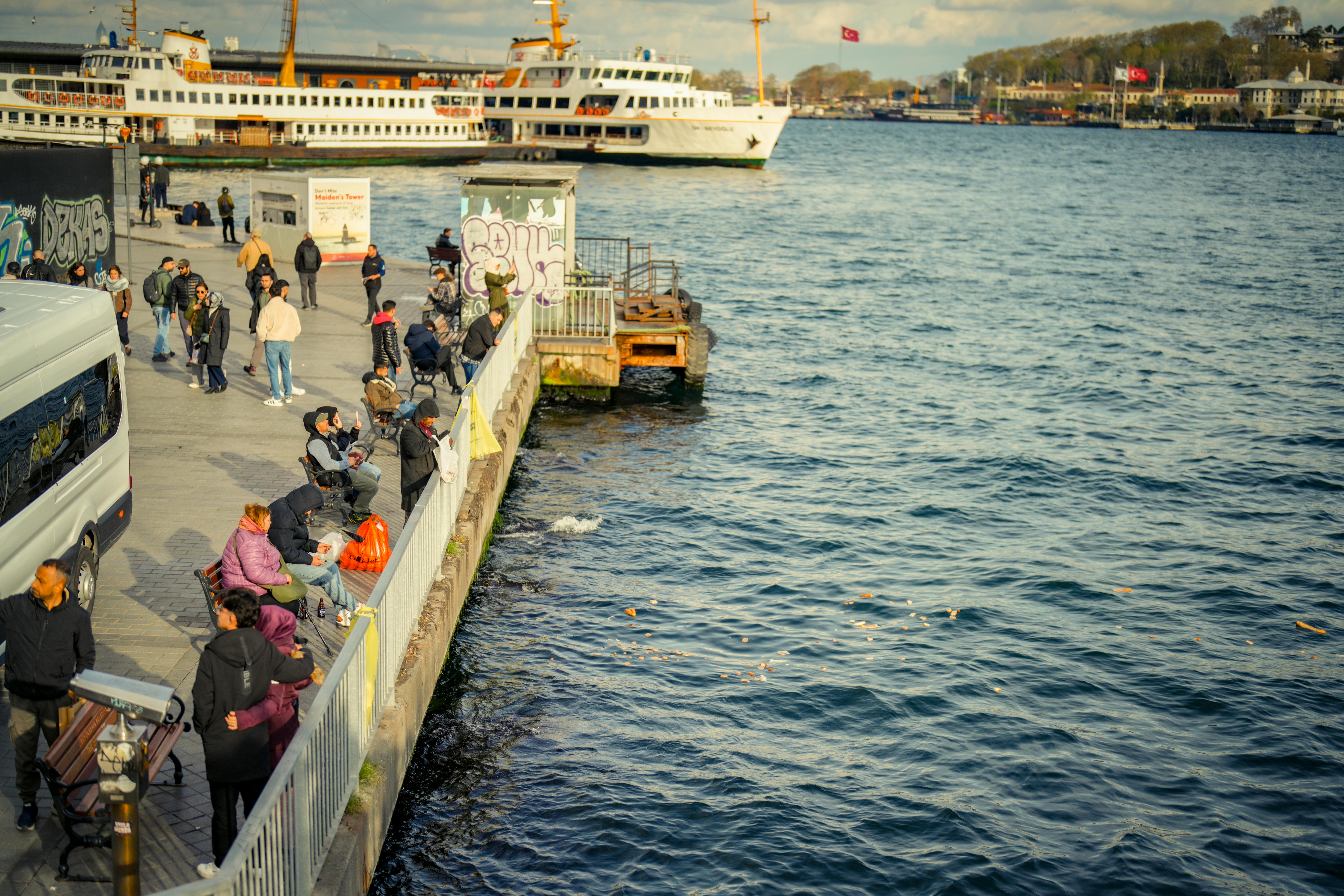 Busy Waterfront Scene with Ferries and People · Free Stock Photo