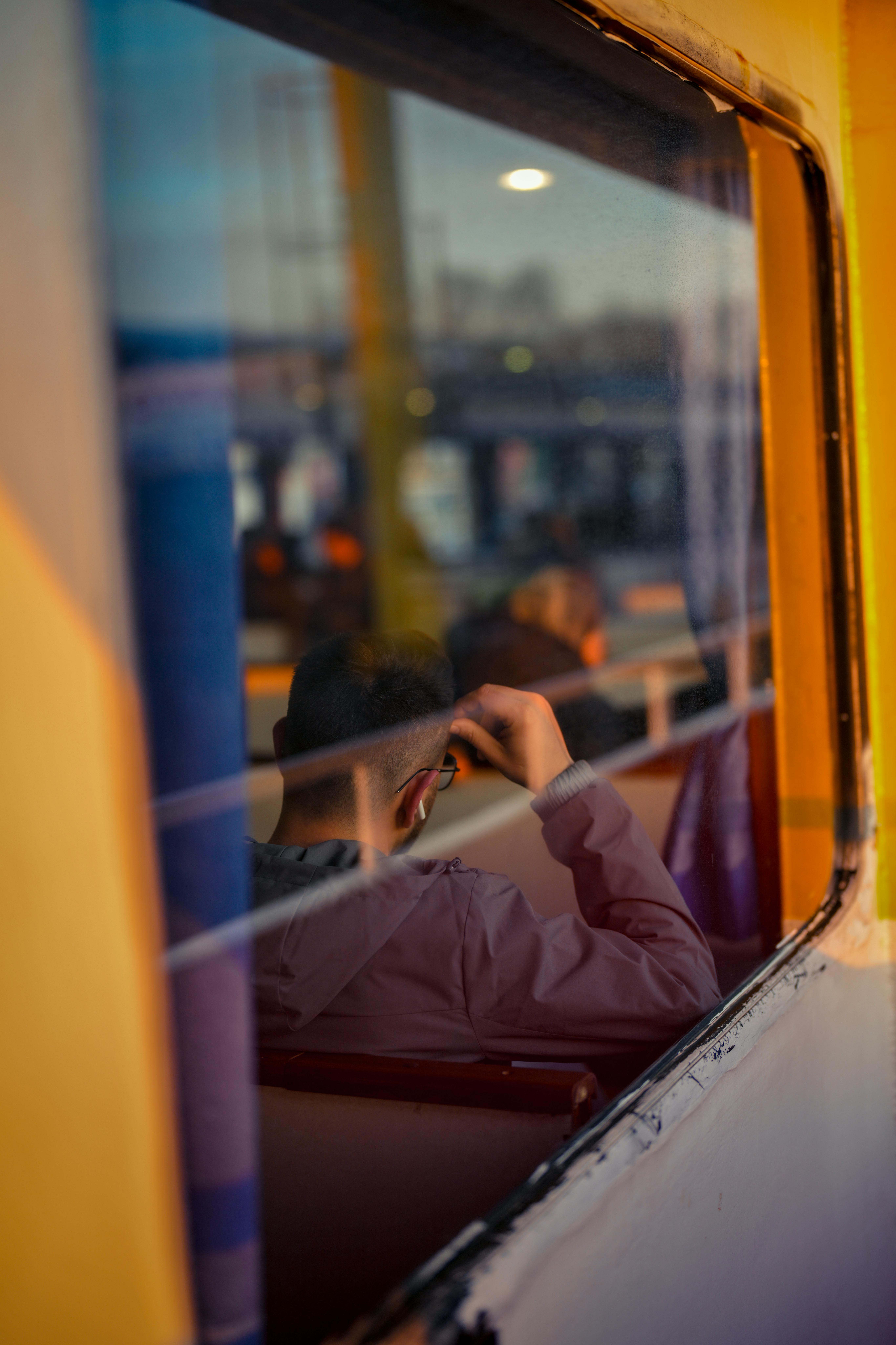 Reflective Thought Through Train Window at Dusk · Free Stock Photo