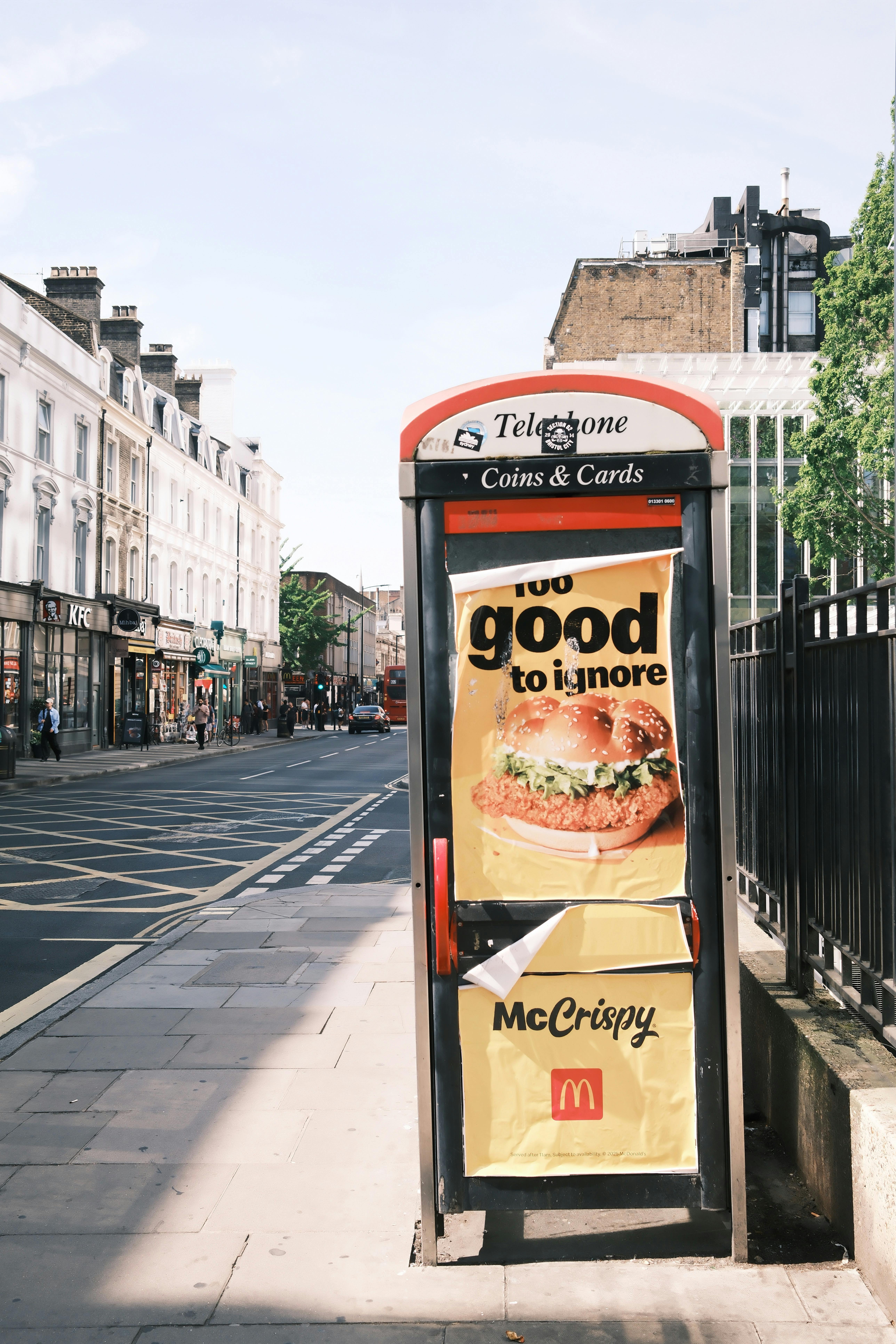 Iconic London Phone Booth with McCrispy Ad · Free Stock Photo