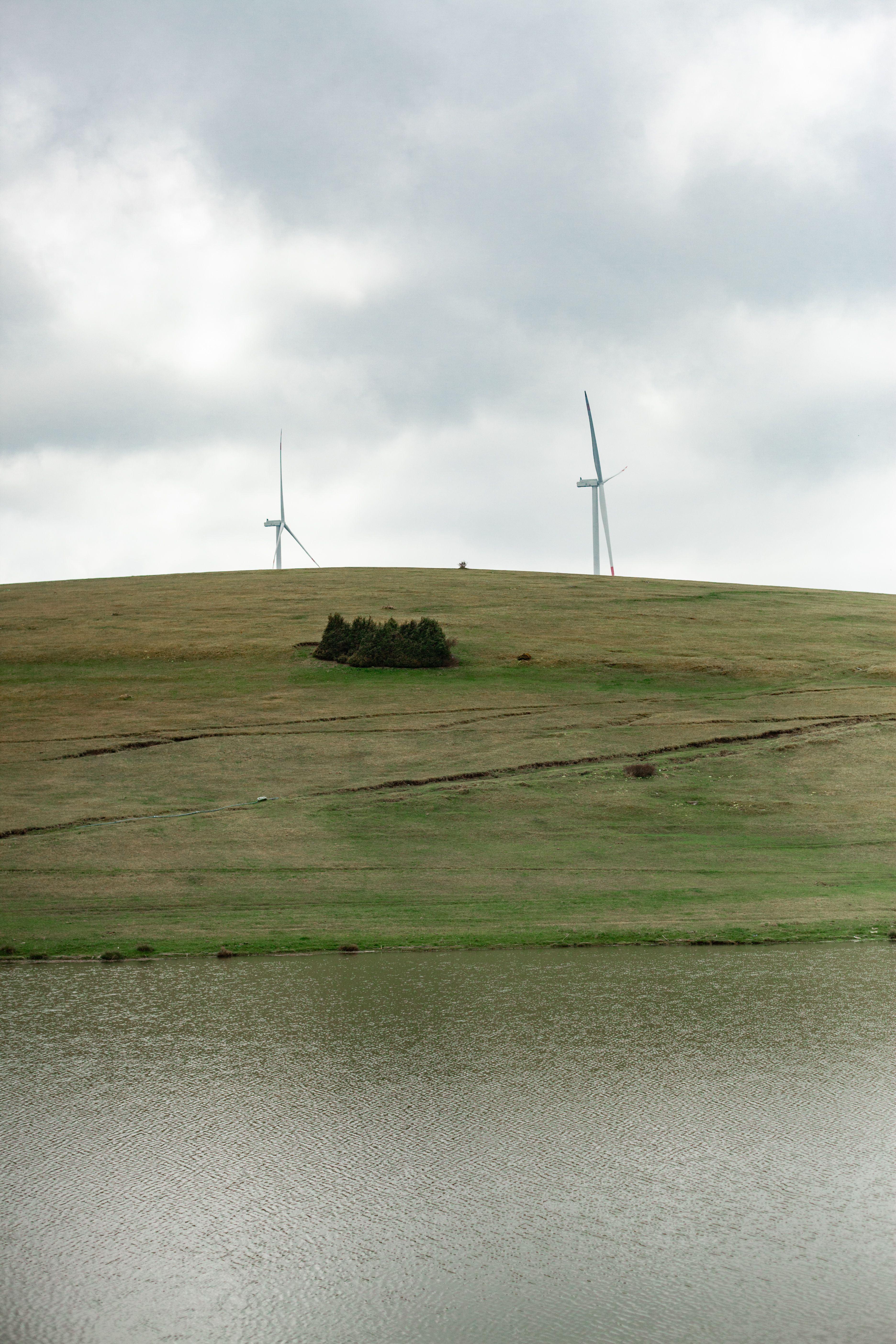 Wind Turbines on a Rolling Green Hill Landscape · Free Stock Photo