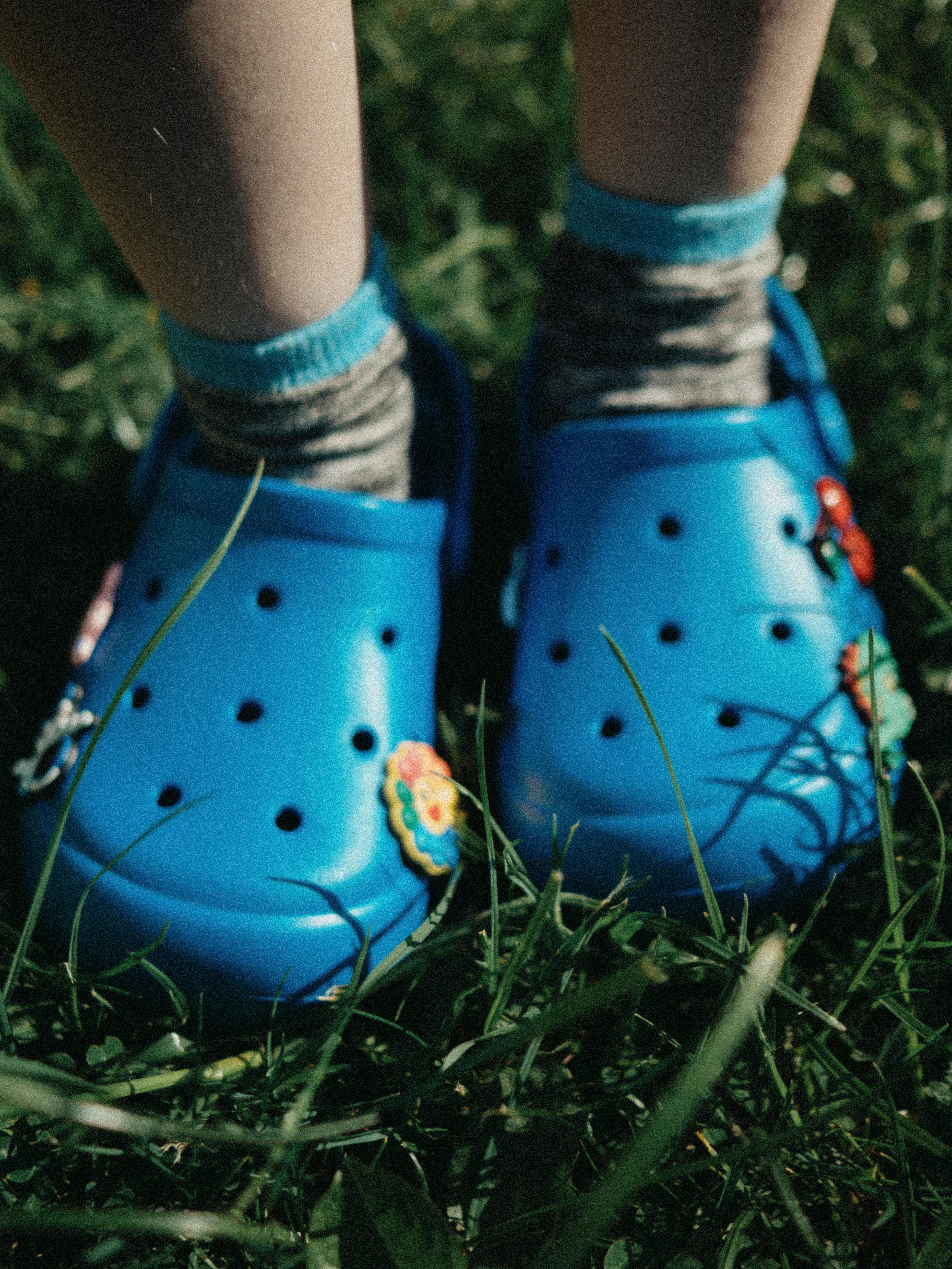 Child Wearing Blue Crocs on Grass · Free Stock Photo