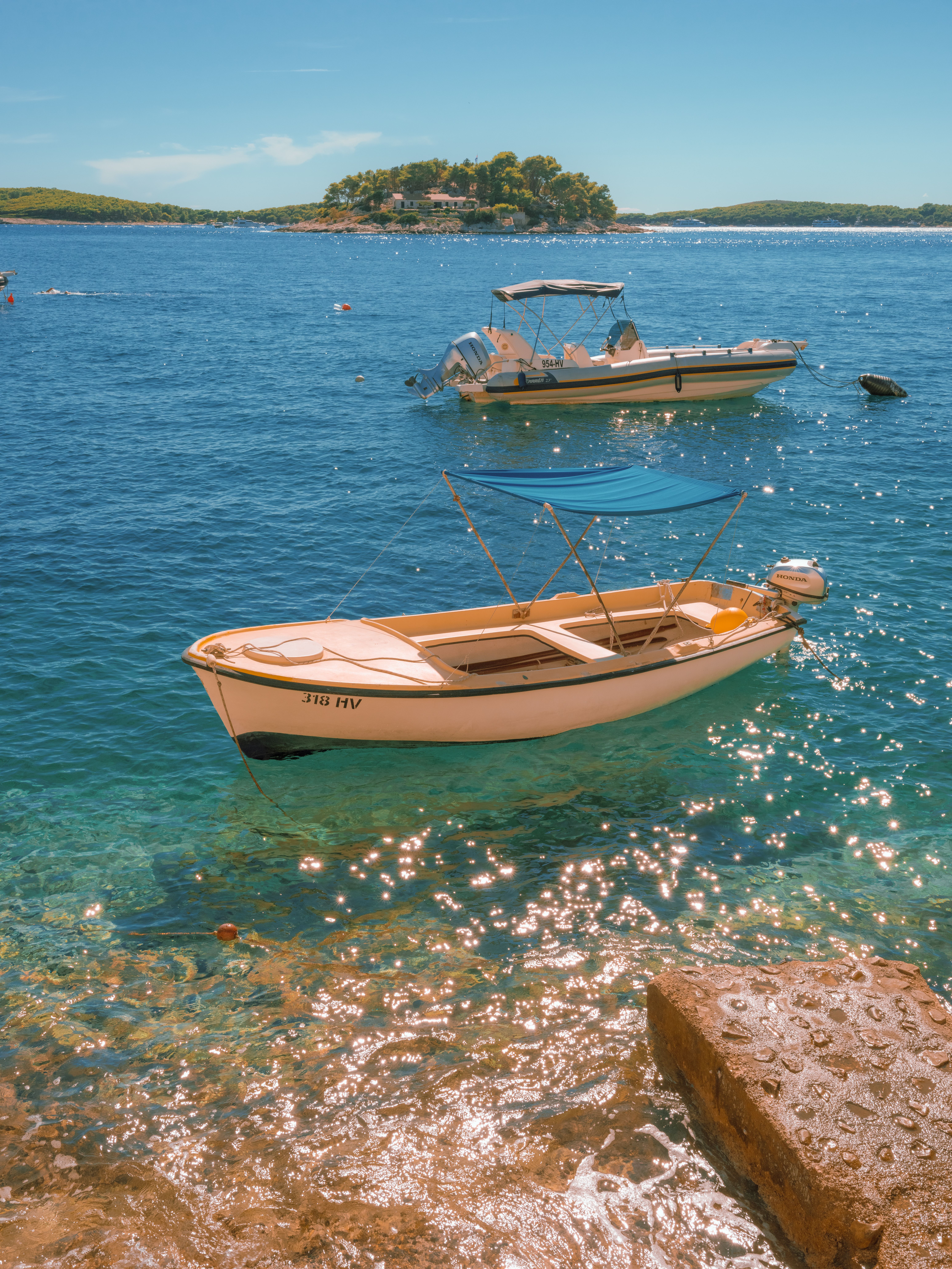 Sunny Day with Boats in Vibrant Blue Seas · Free Stock Photo