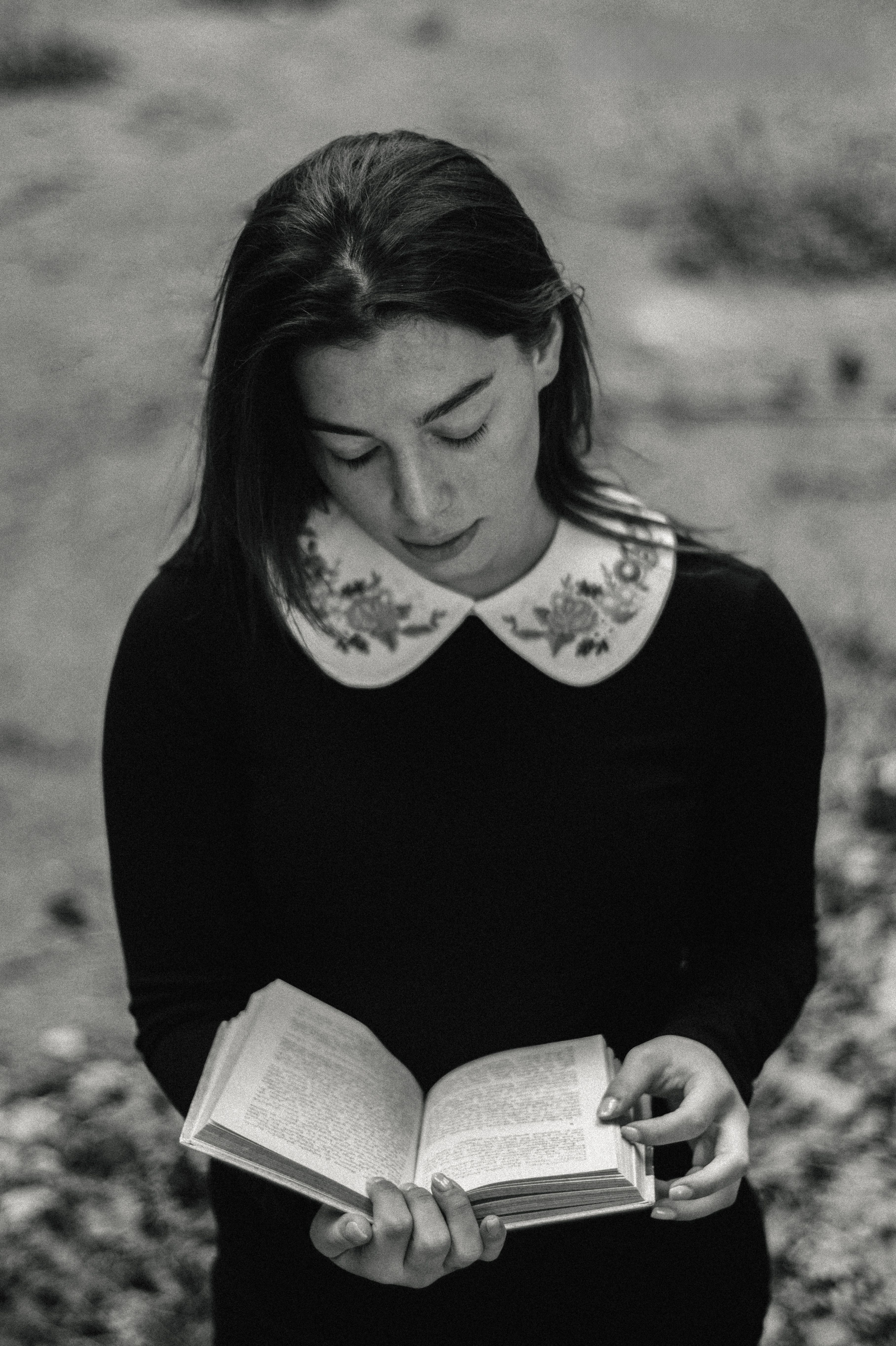 Monochrome Portrait of Woman Reading Outdoors · Free Stock Photo