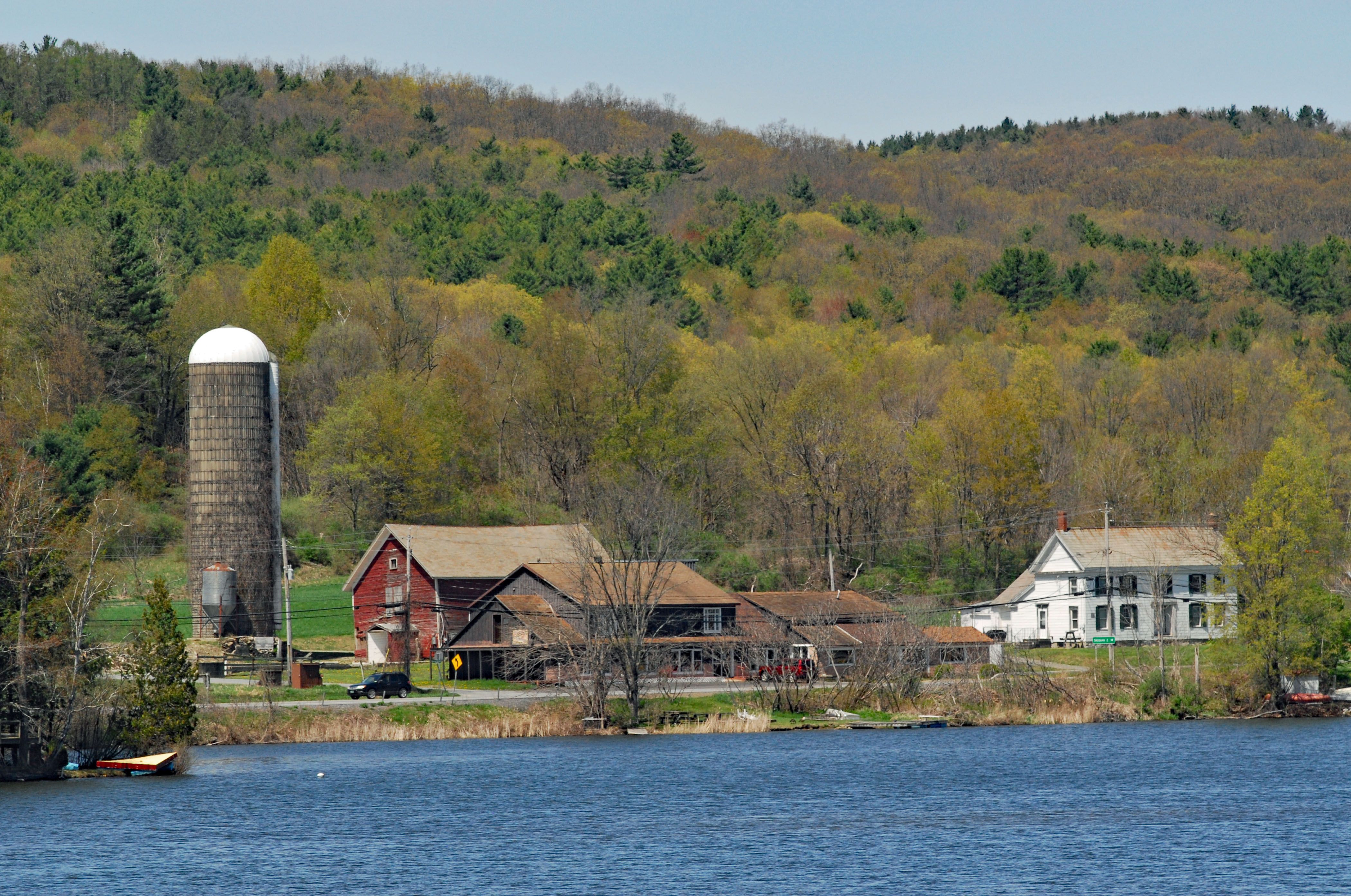Scenic Rural Farm by Lake in Spring · Free Stock Photo