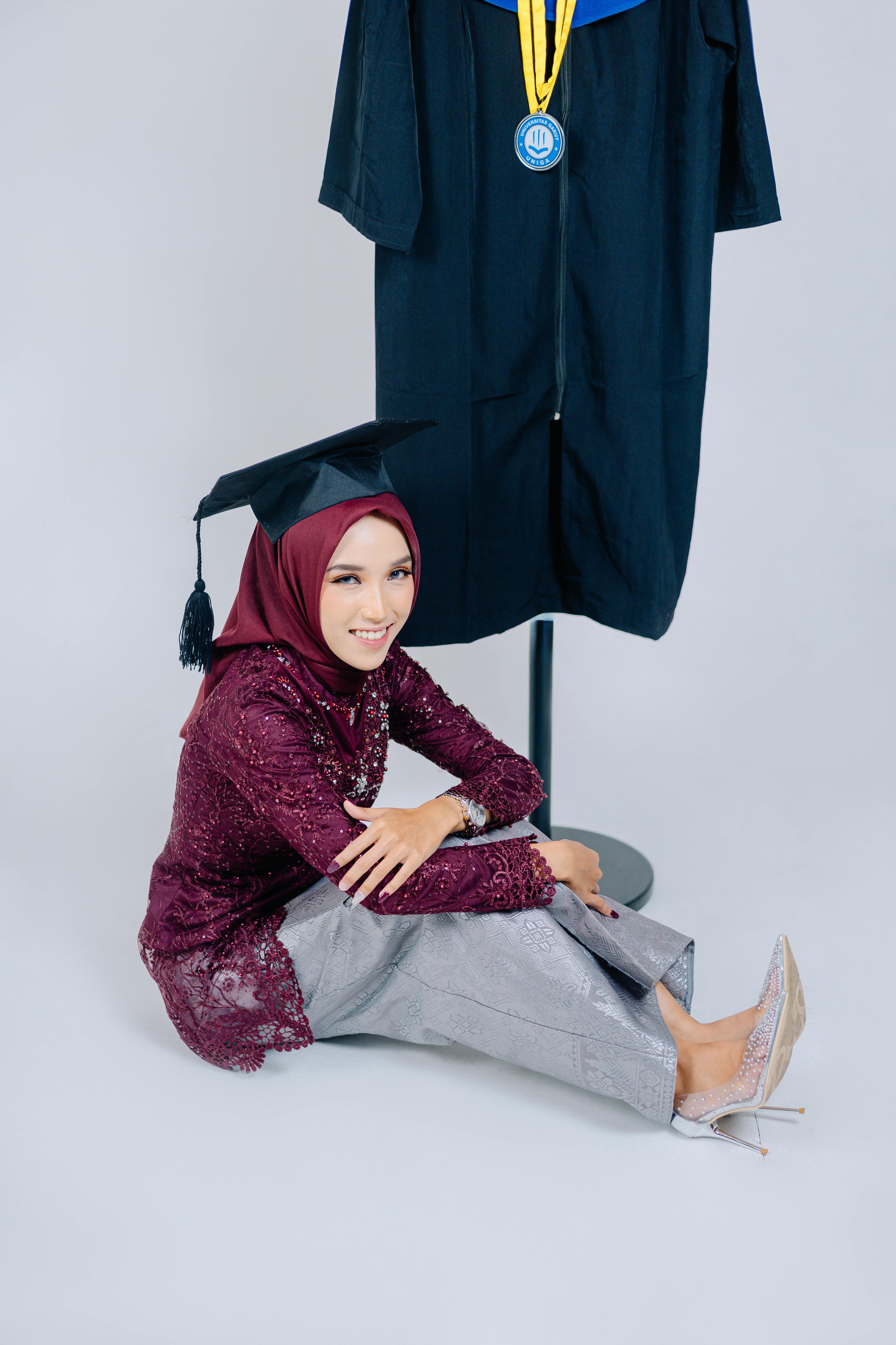 Indonesian Graduate Celebrating Achievement Indoors · Free Stock Photo