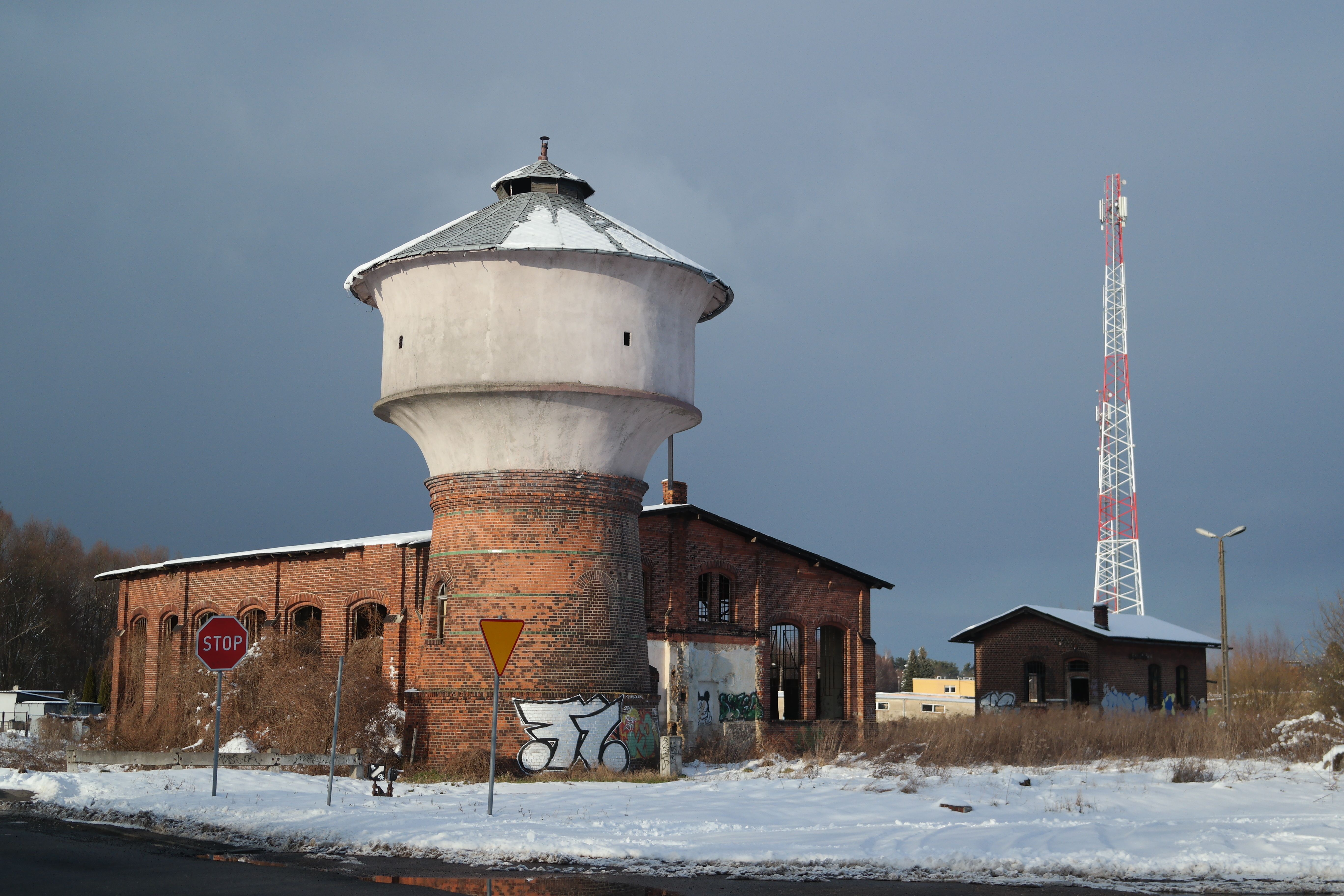 Old Brick Water Tower in Winter Urban Setting · Free Stock Photo