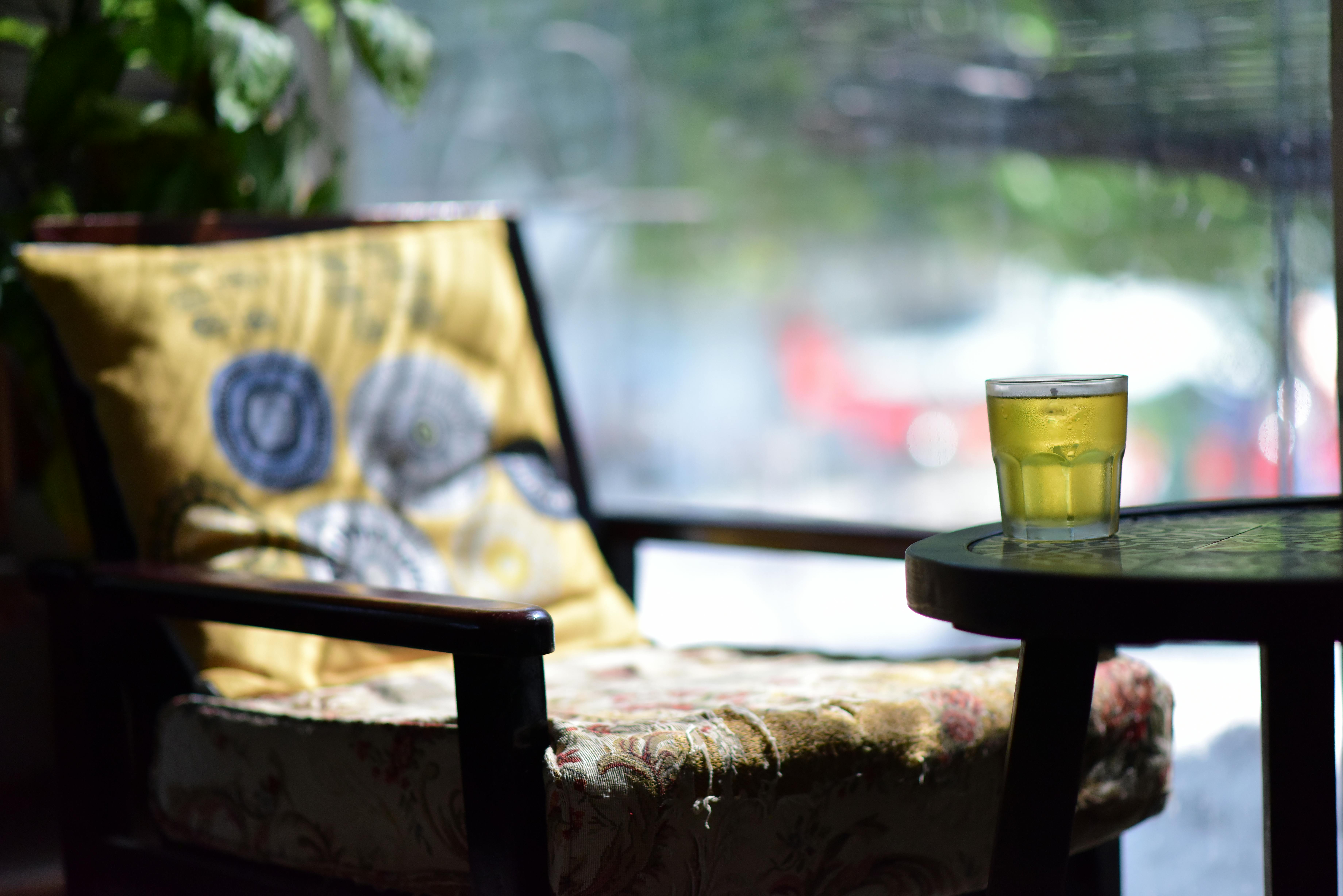 Cozy Cafe Nook with Ice Tea and Cushion · Free Stock Photo