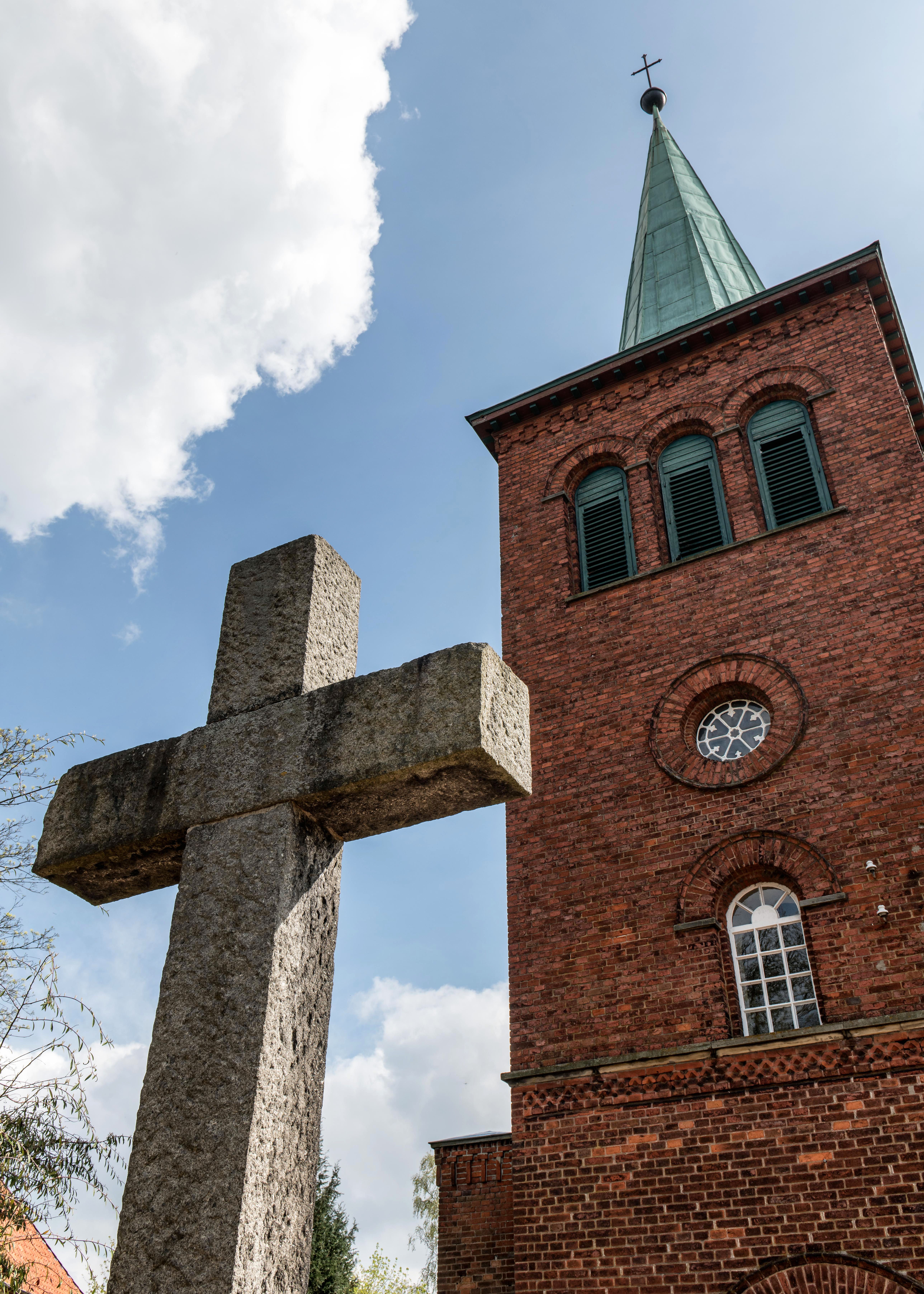 Historic Brick Church with Prominent Stone Cross · Free Stock Photo