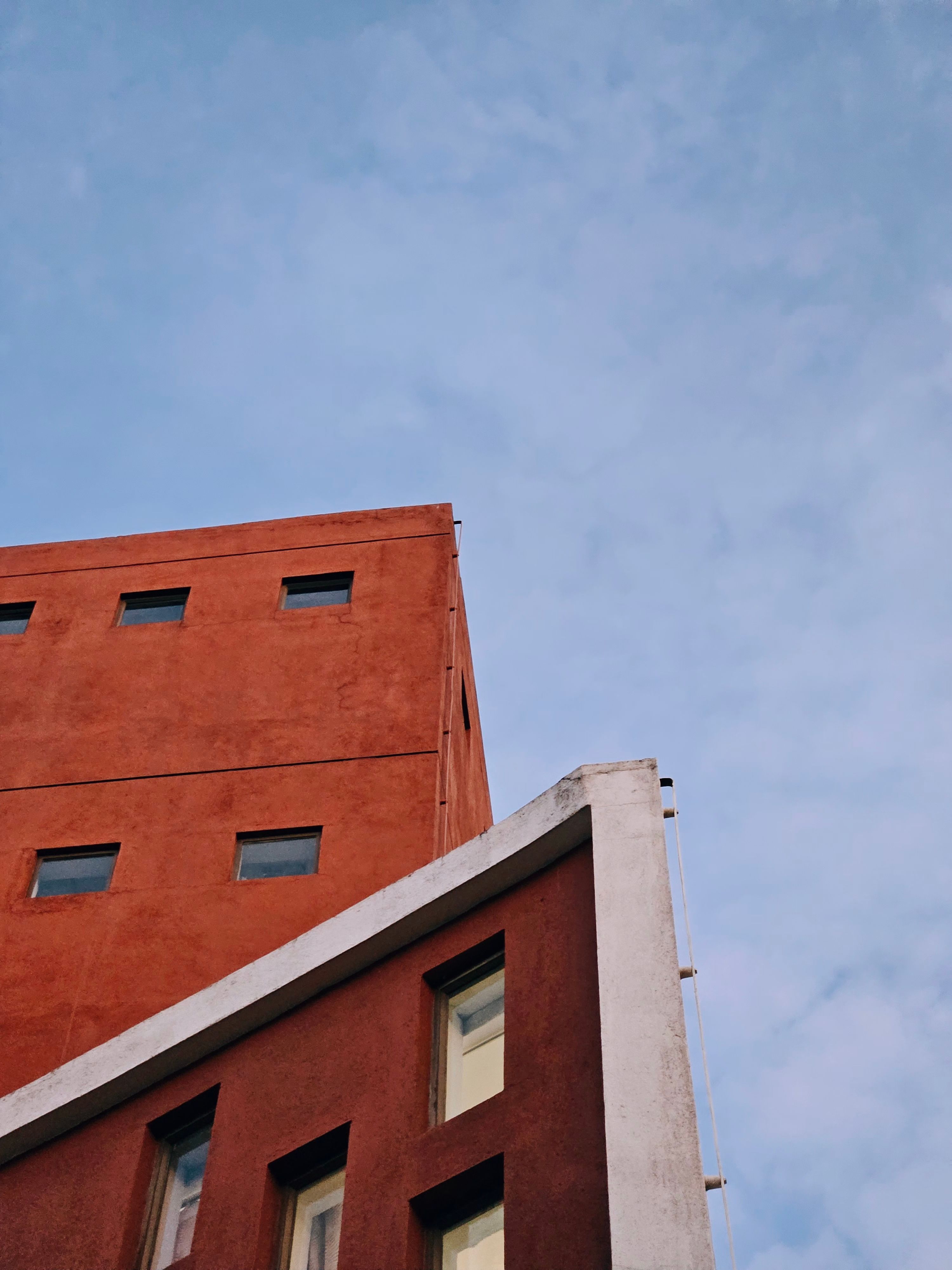 Modern Red Building Against Blue Sky · Free Stock Photo