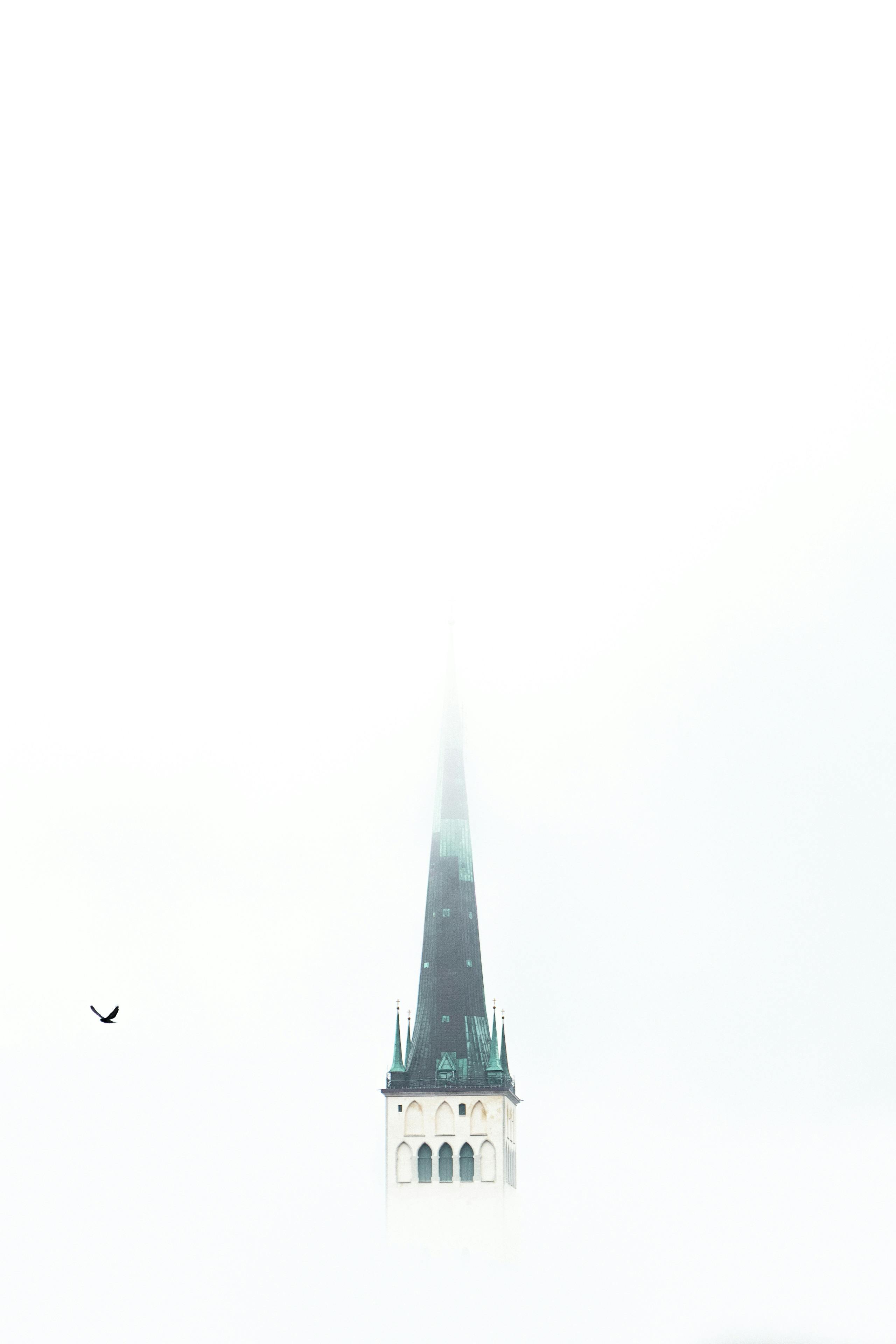 Gothic Church Spire Emerging Through Mist · Free Stock Photo