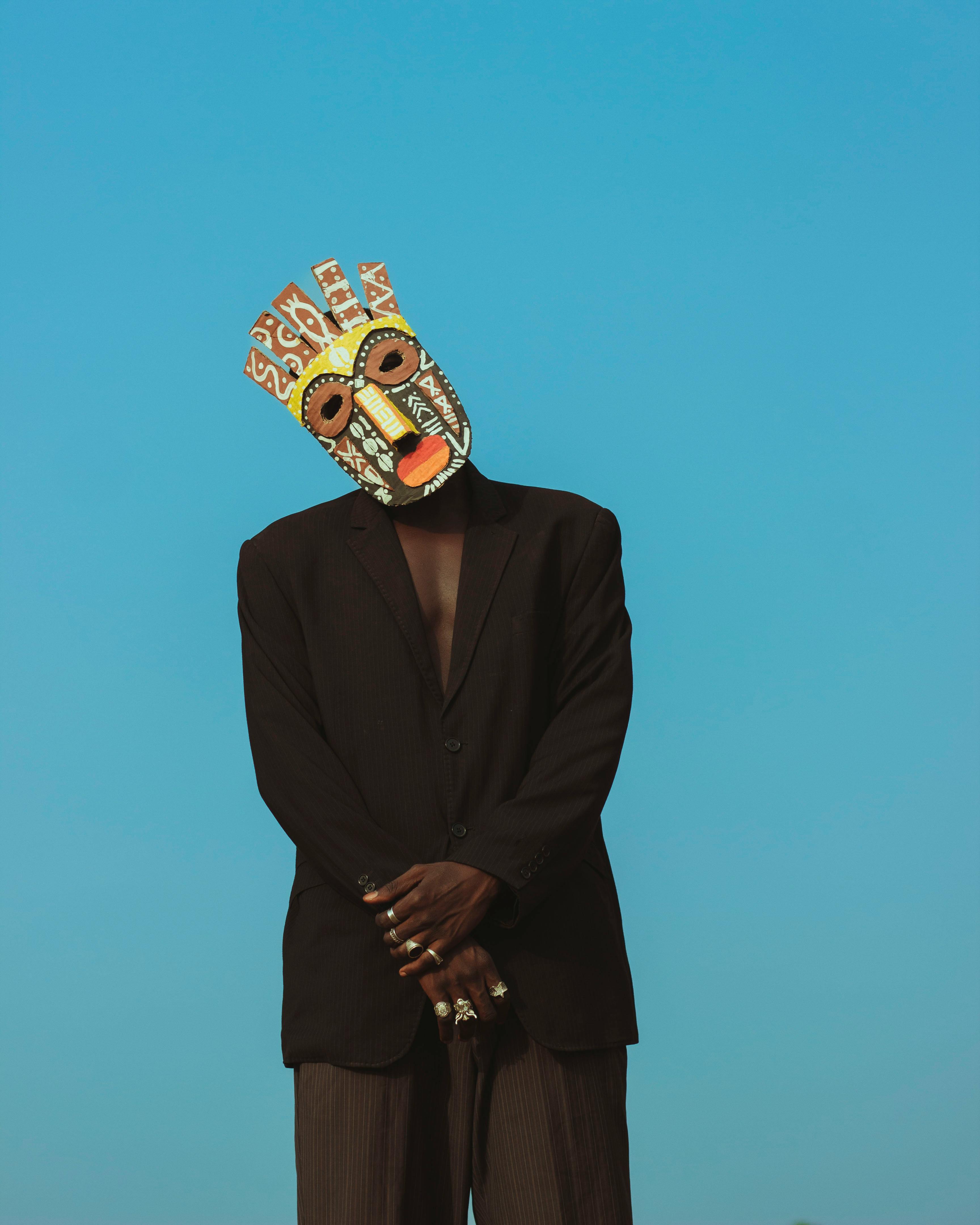 Colorful Traditional Mask on Person in Suit · Free Stock Photo