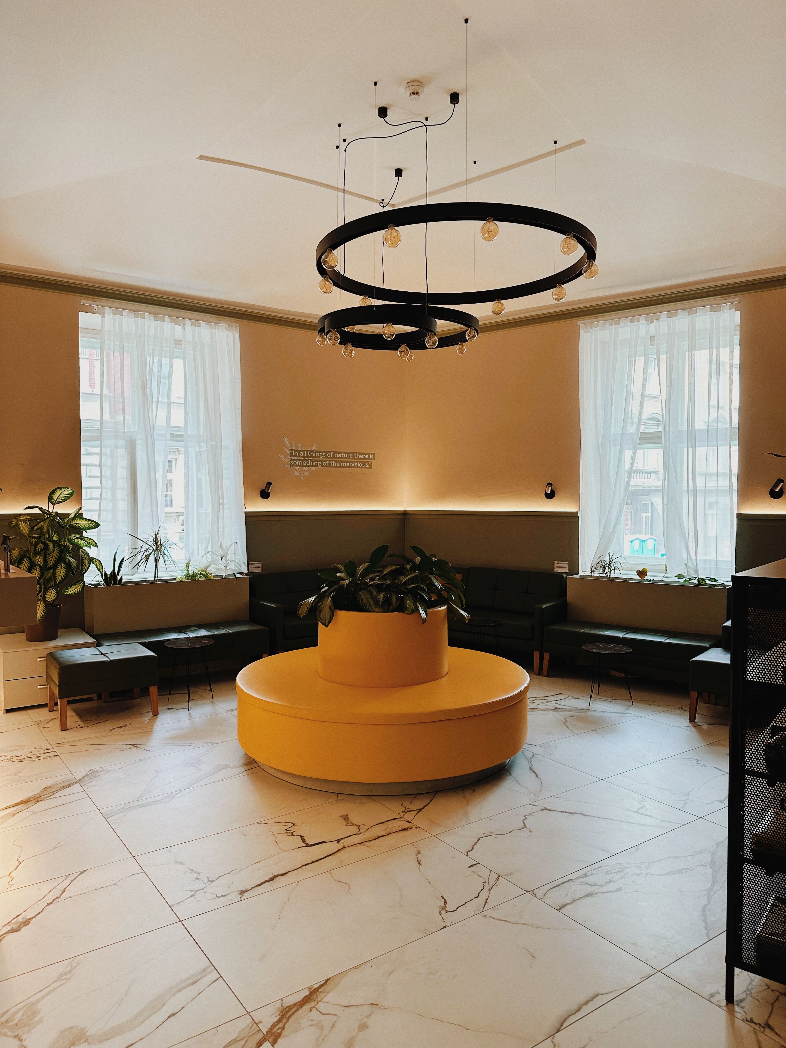 Modern Lobby with Circular Seating and Pendant Light · Free Stock Photo