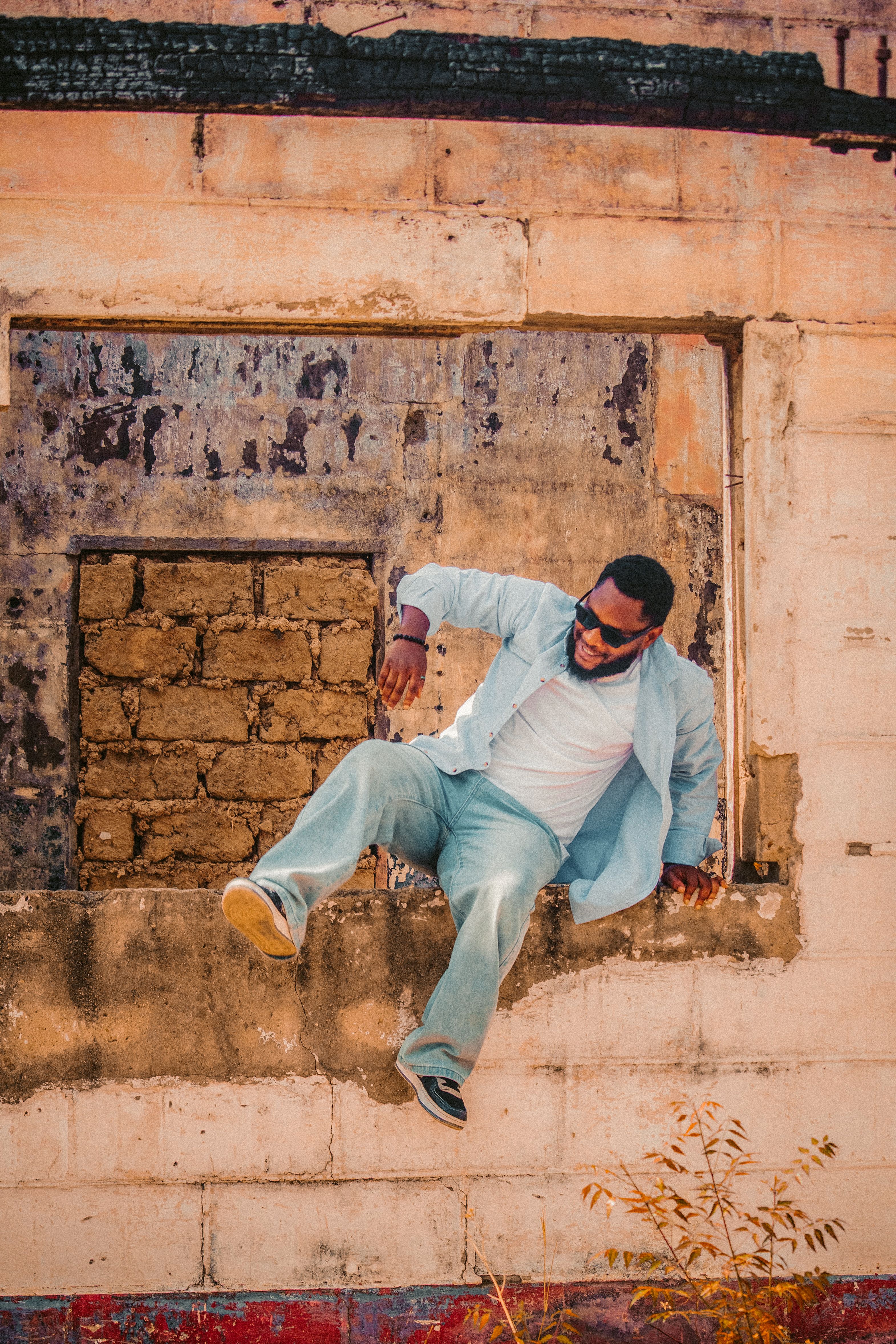 Man Climbing Out of Abandoned Building Window · Free Stock Photo