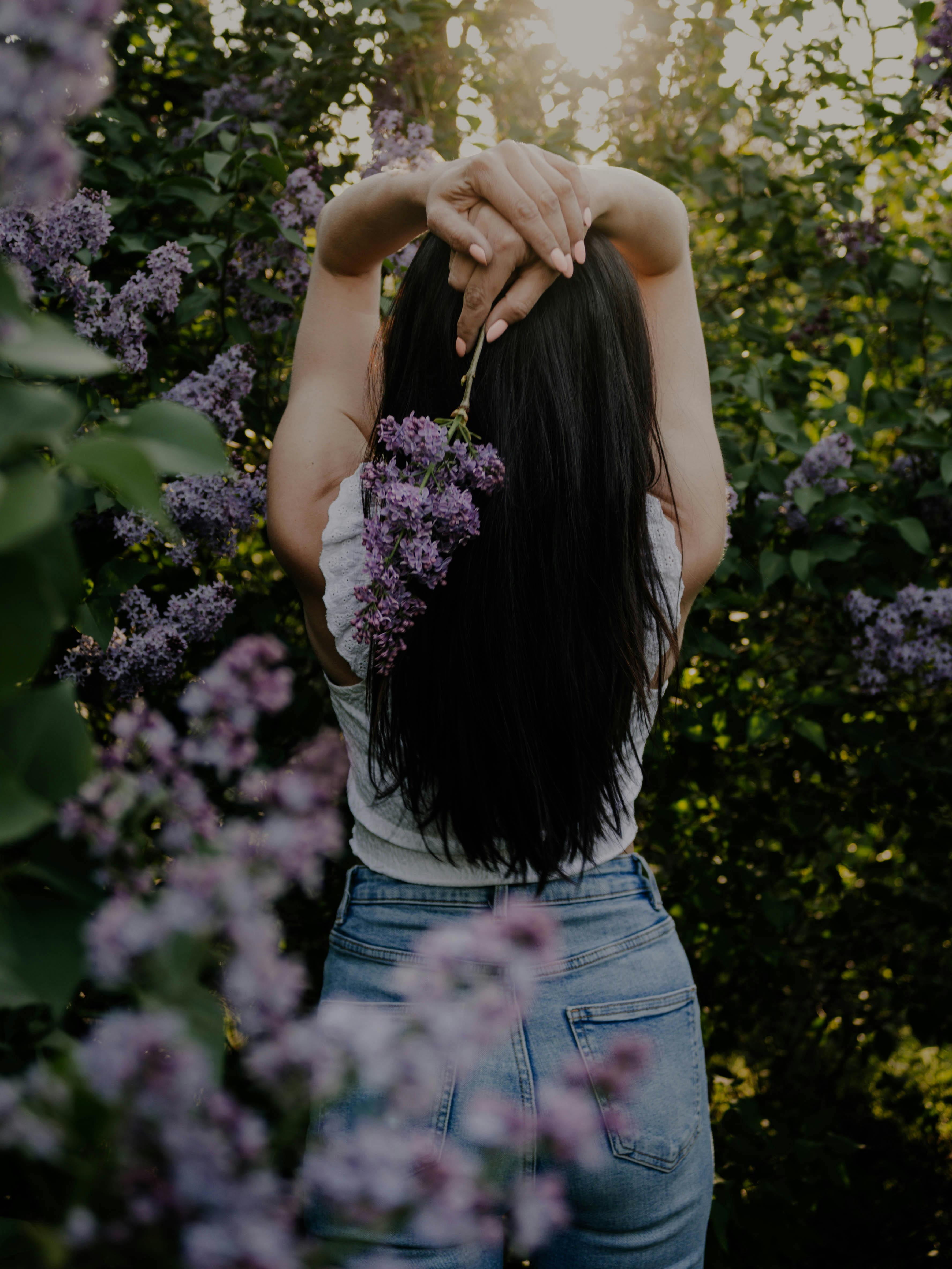 Woman in Floral Garden at Sunset Back View · Free Stock Photo