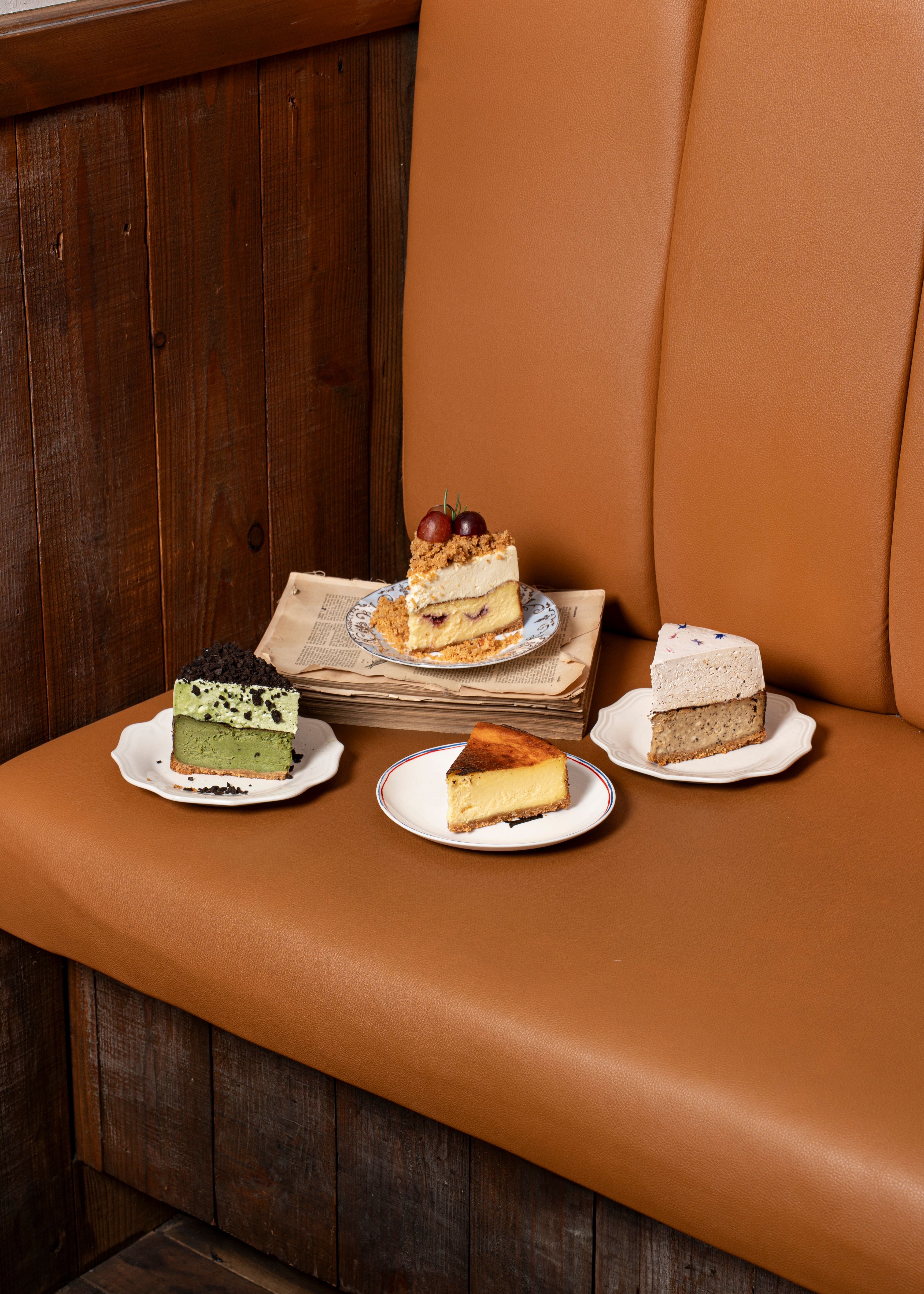 Assorted Cake Slices on Brown Sofa in Cozy Cafe · Free Stock Photo