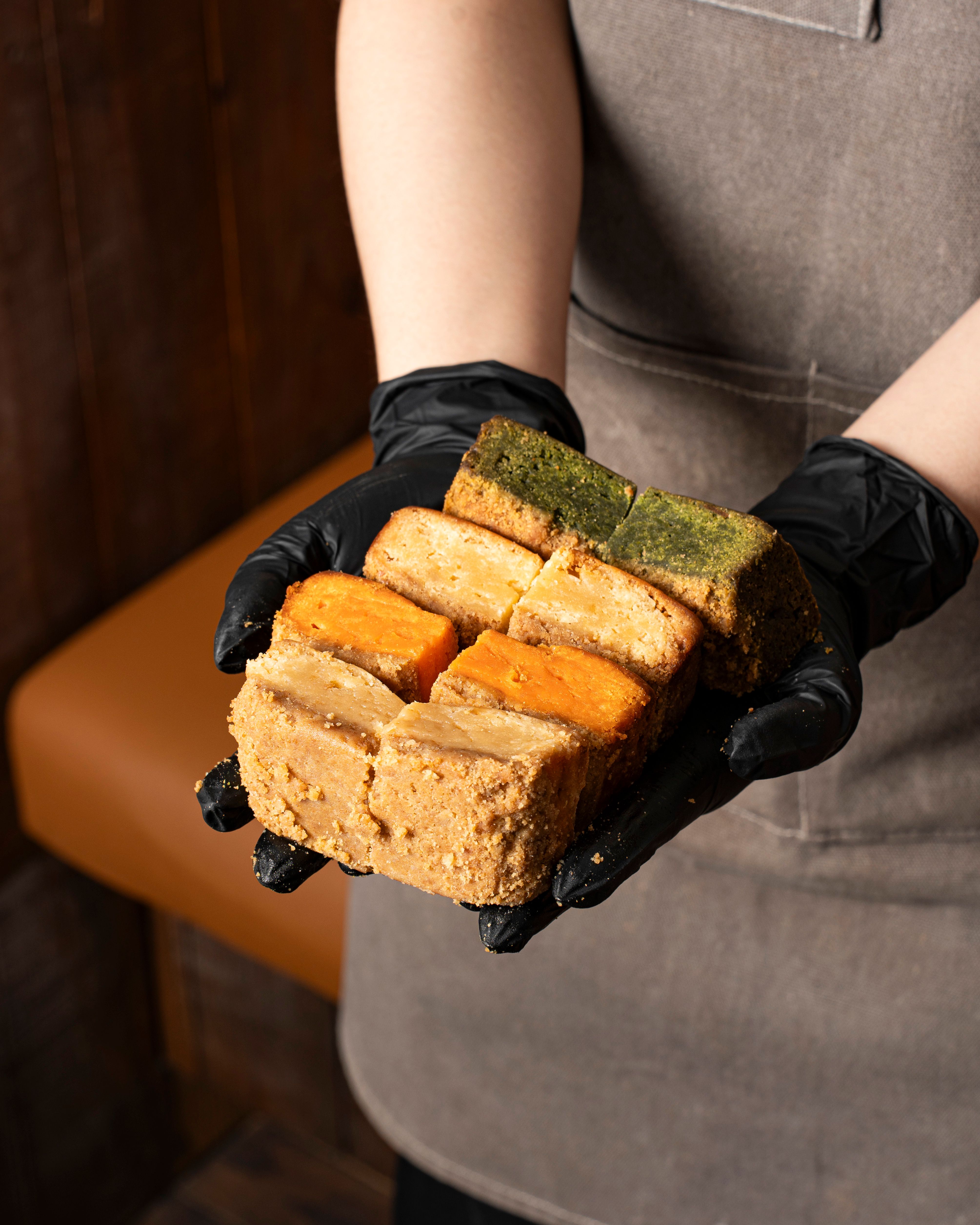 Assorted Cookies Held by Barista in Cafe Setting · Free Stock Photo