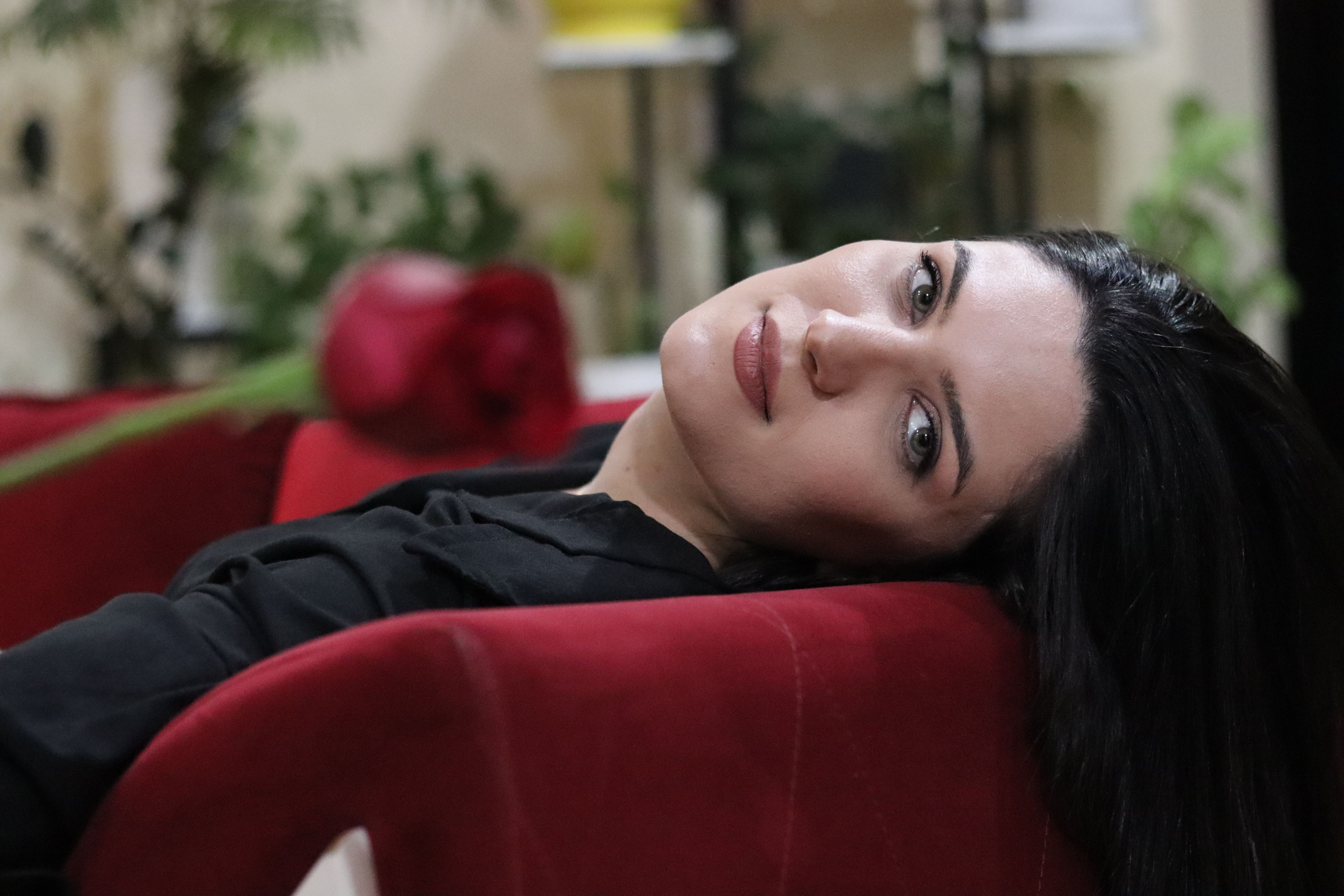 Relaxed Portrait of Woman with Rose Indoors · Free Stock Photo