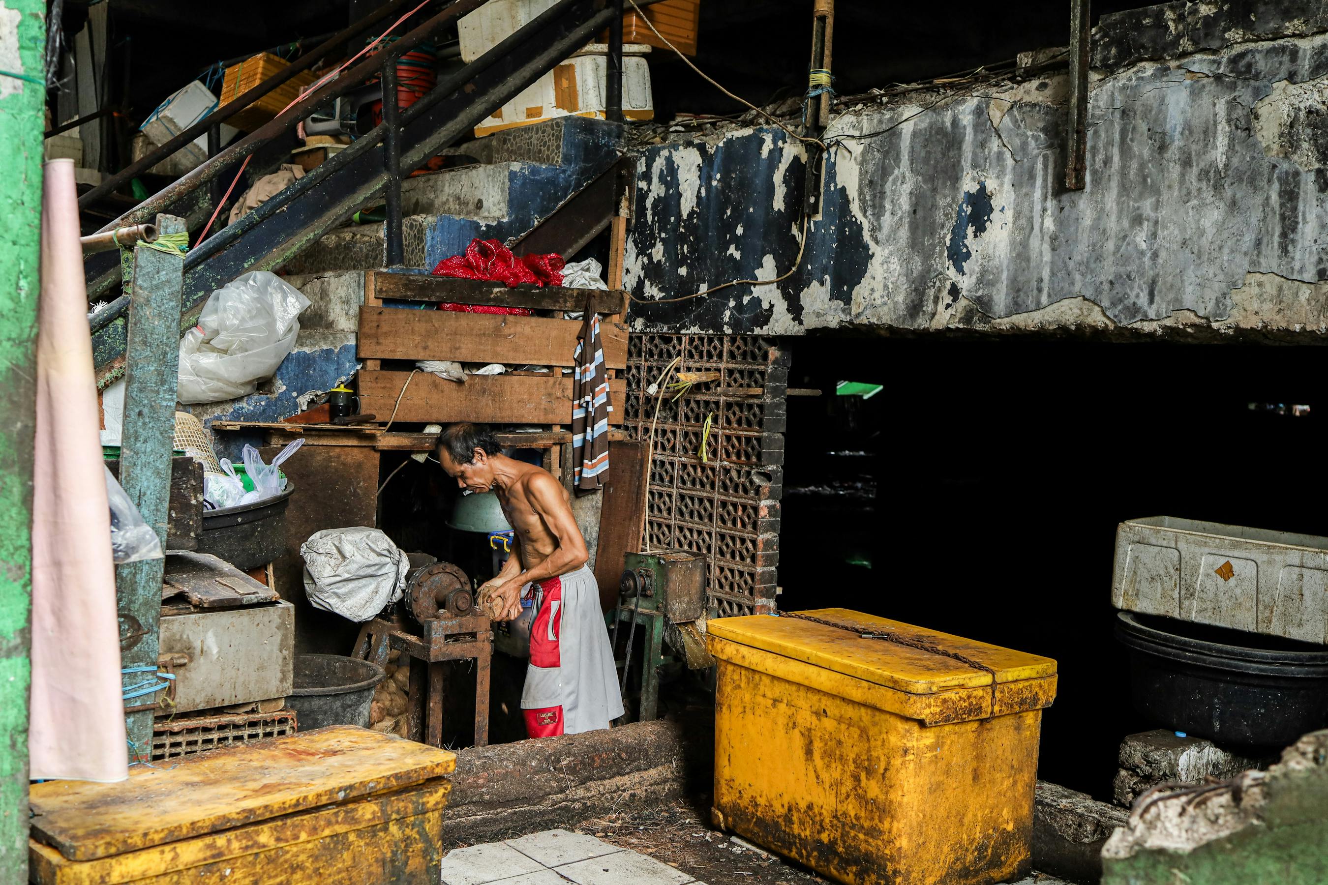 Man in Urban Alleyway Amid Industrial Clutter · Free Stock Photo