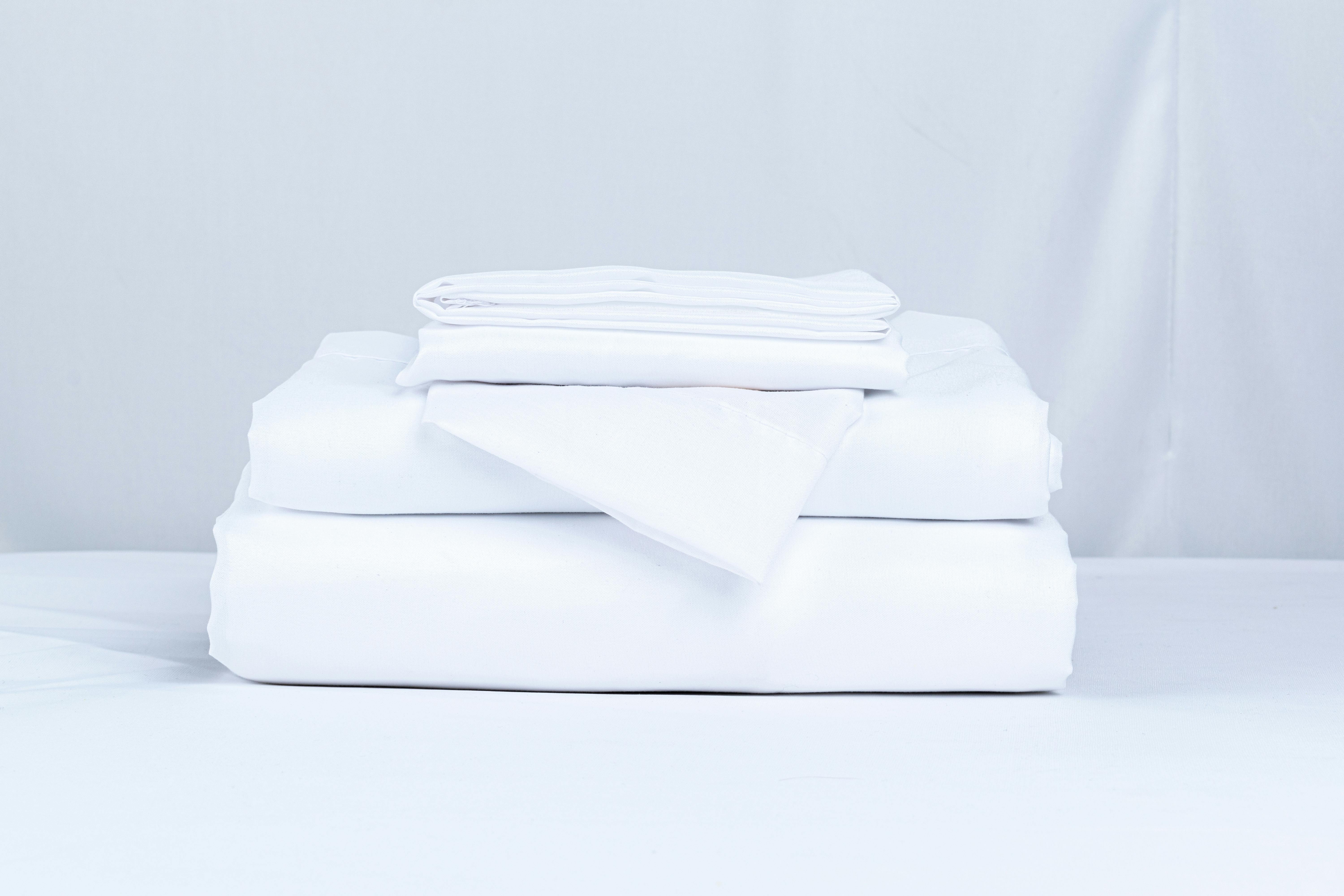 Stack of Clean White Bedding Linens · Free Stock Photo