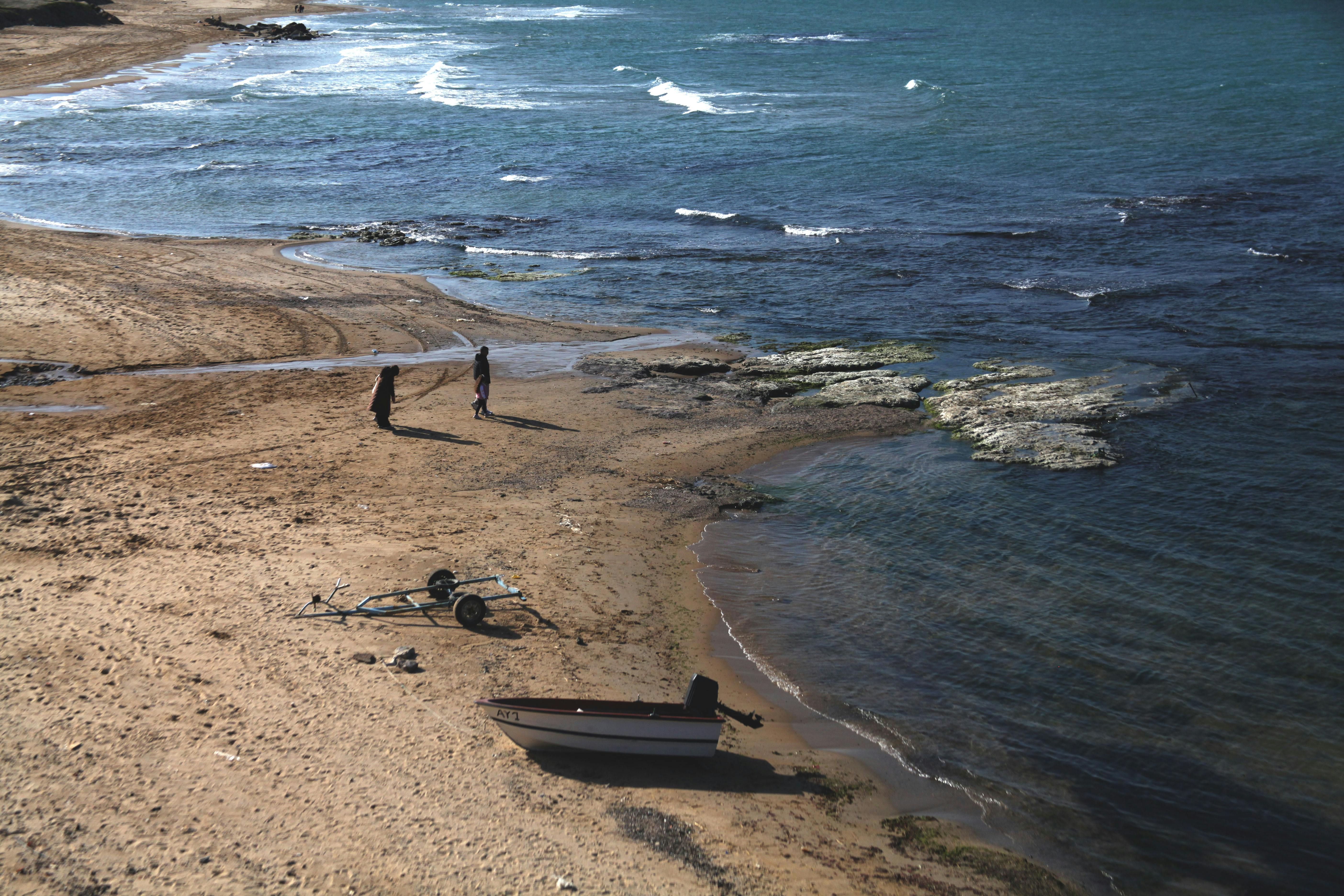 Scenic İstanbul Beach with Rowboat and Waves · Free Stock Photo