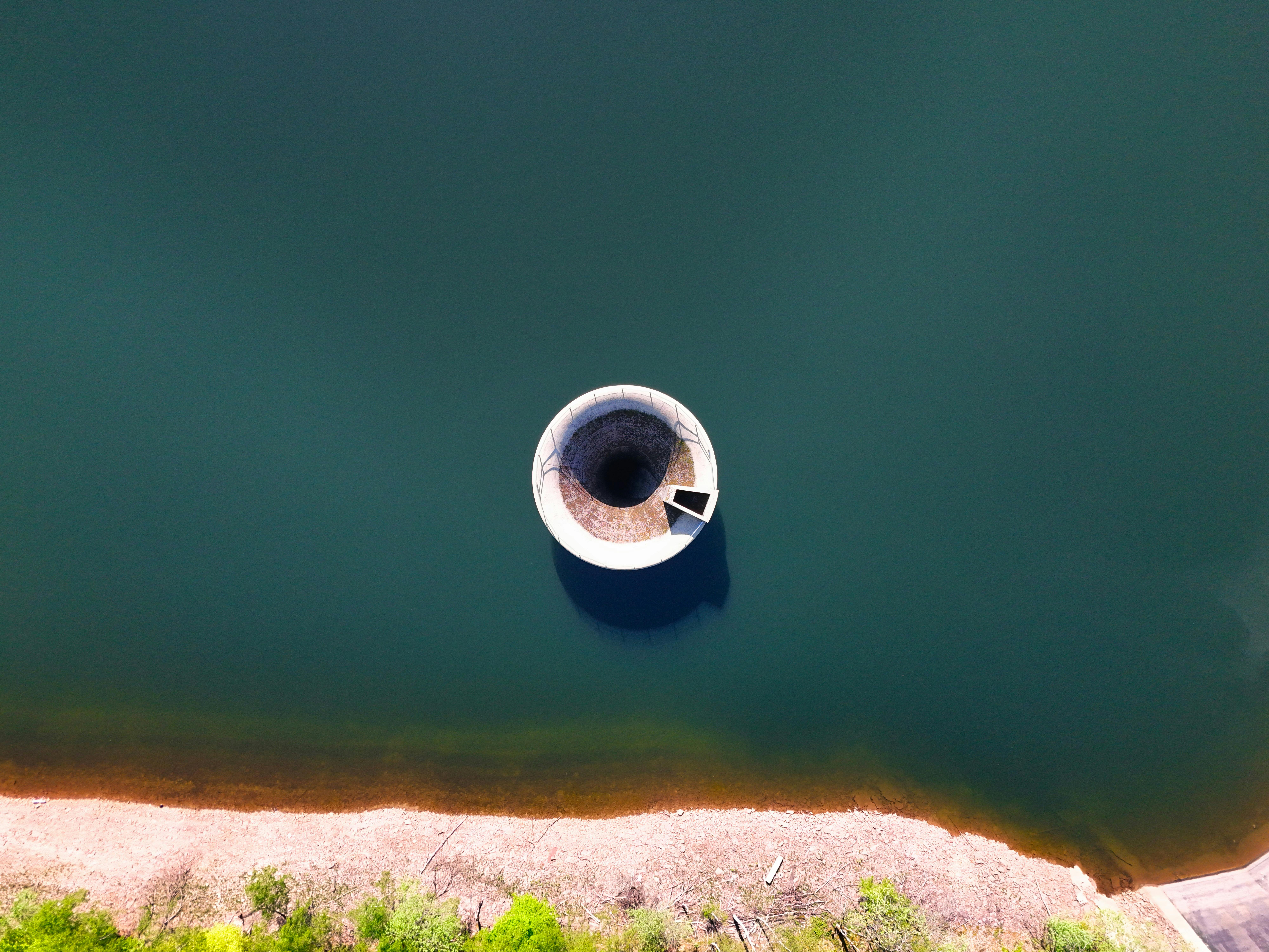 Aerial View of Circular Spillway in Reservoir · Free Stock Photo