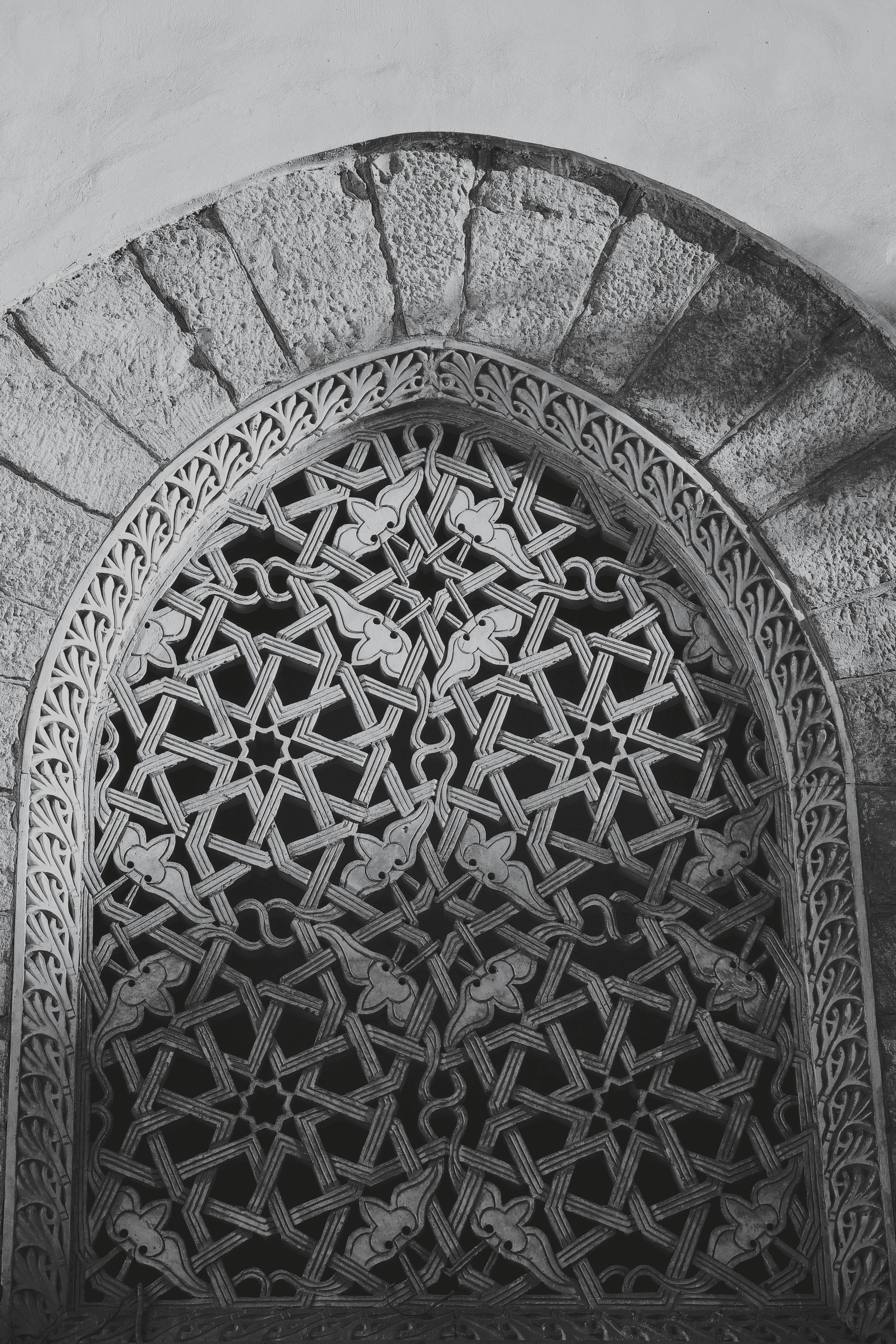 Intricate Stonework of Historic Arched Window · Free Stock Photo