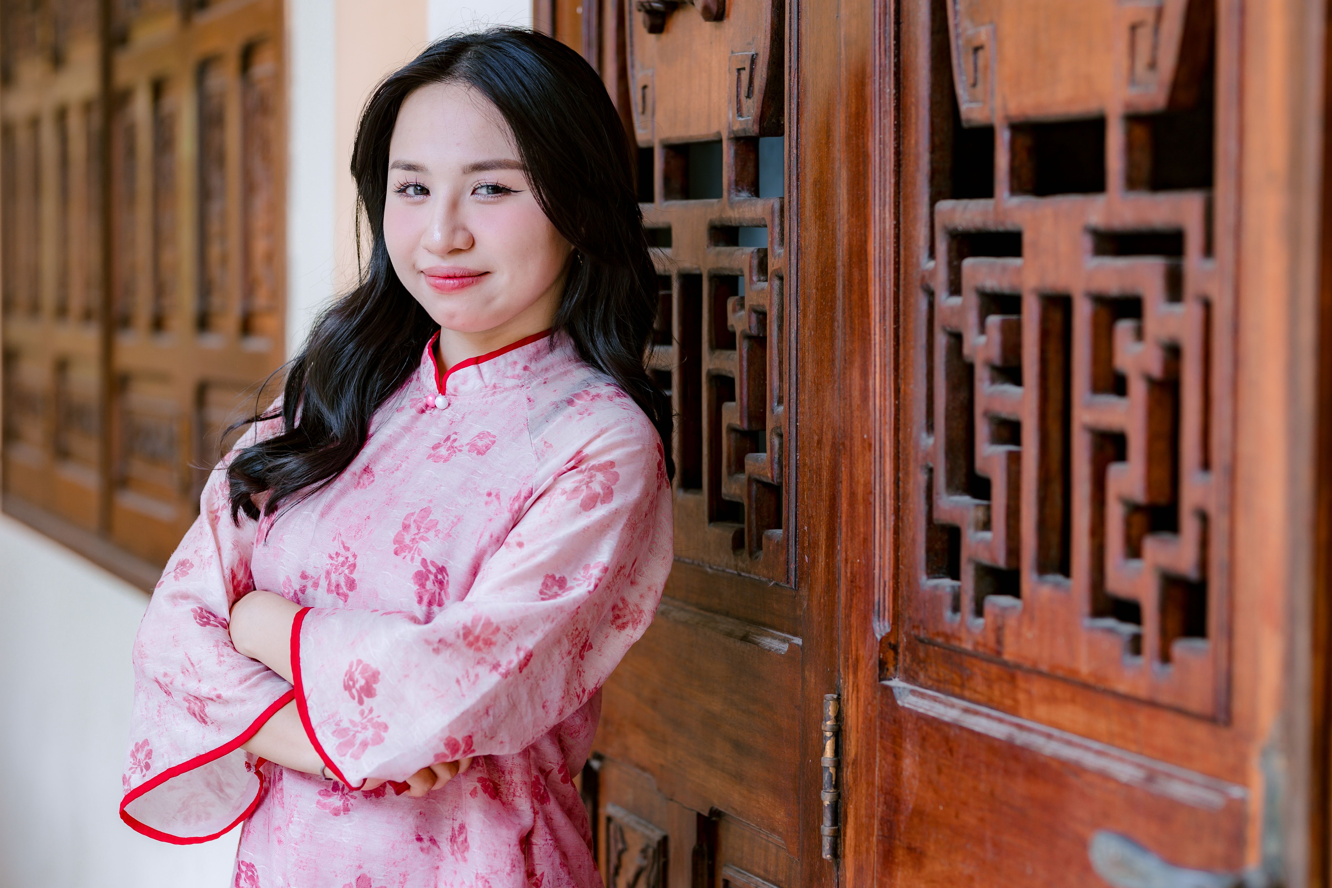 Smiling Woman in Traditional Pink Cheongsam · Free Stock Photo