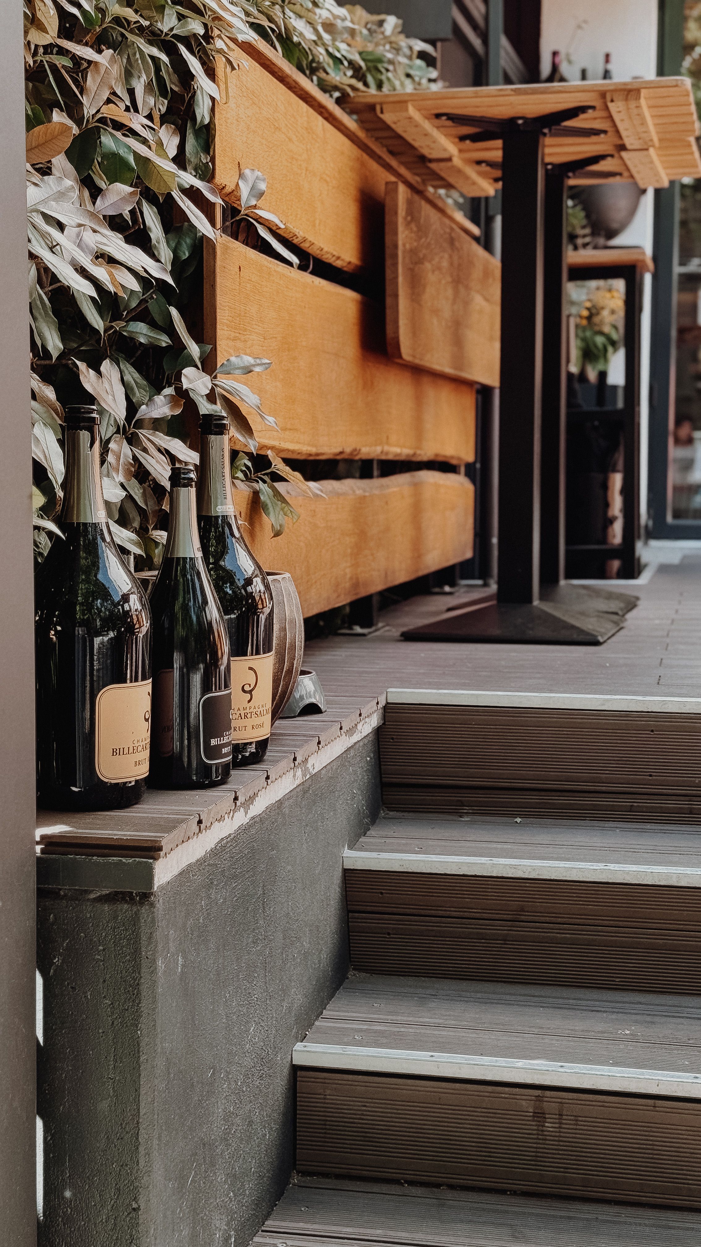 Cozy Outdoor Cafe with Wine Bottles on Display · Free Stock Photo