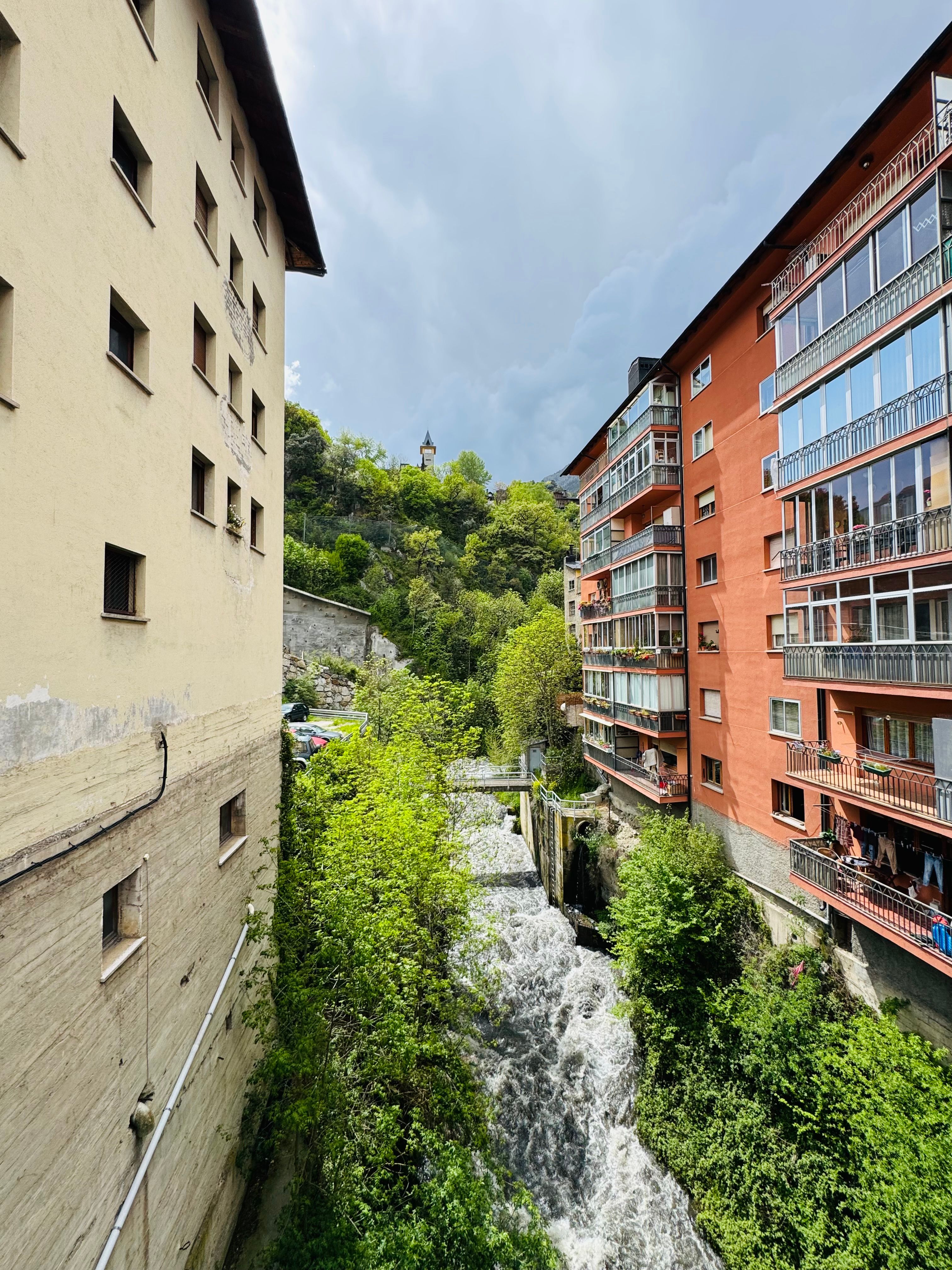 Charming Urban Waterfall View Between Buildings · Free Stock Photo