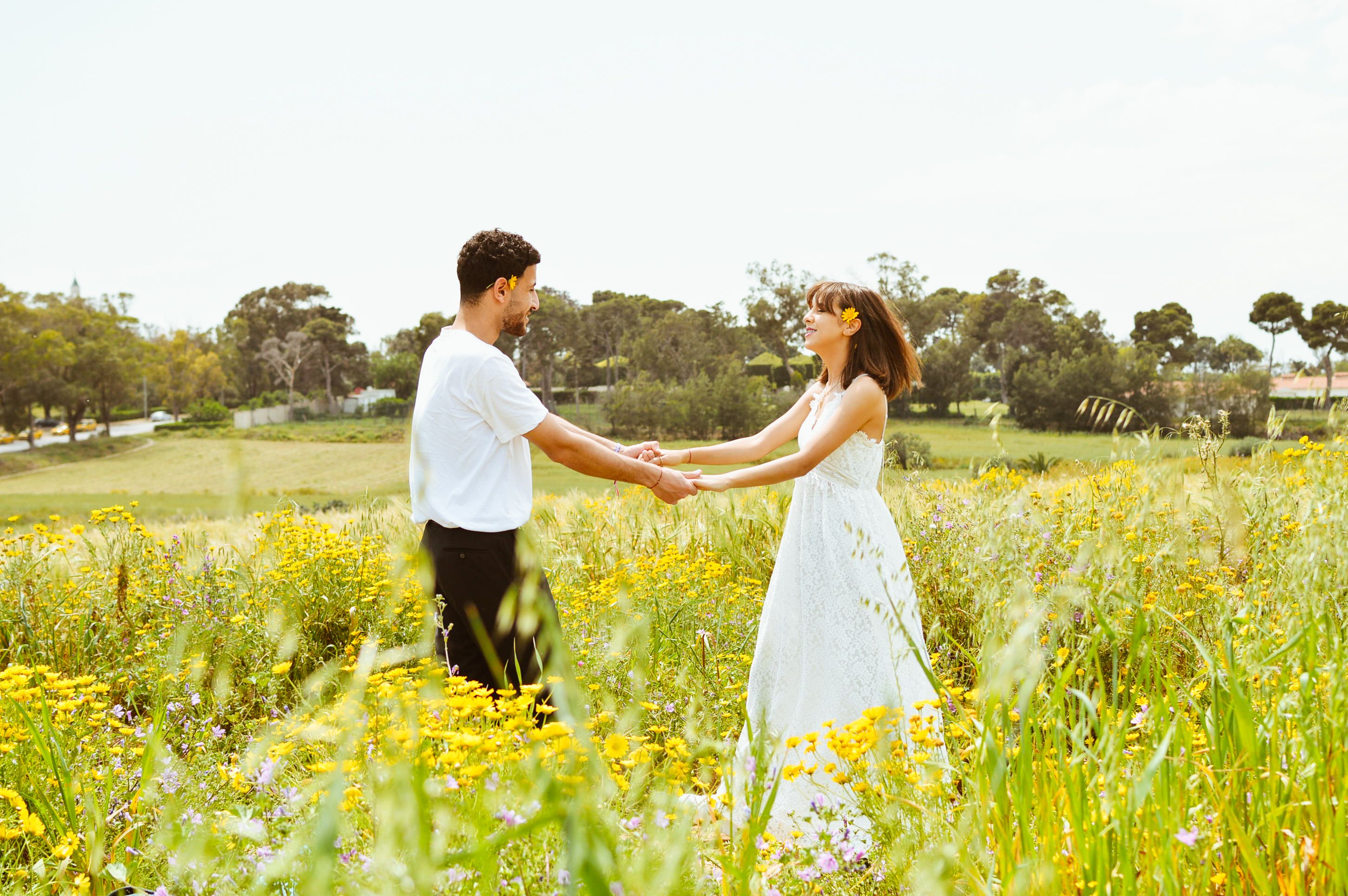 Romantic Couple Holding Hands in Spring Meadow · Free Stock Photo