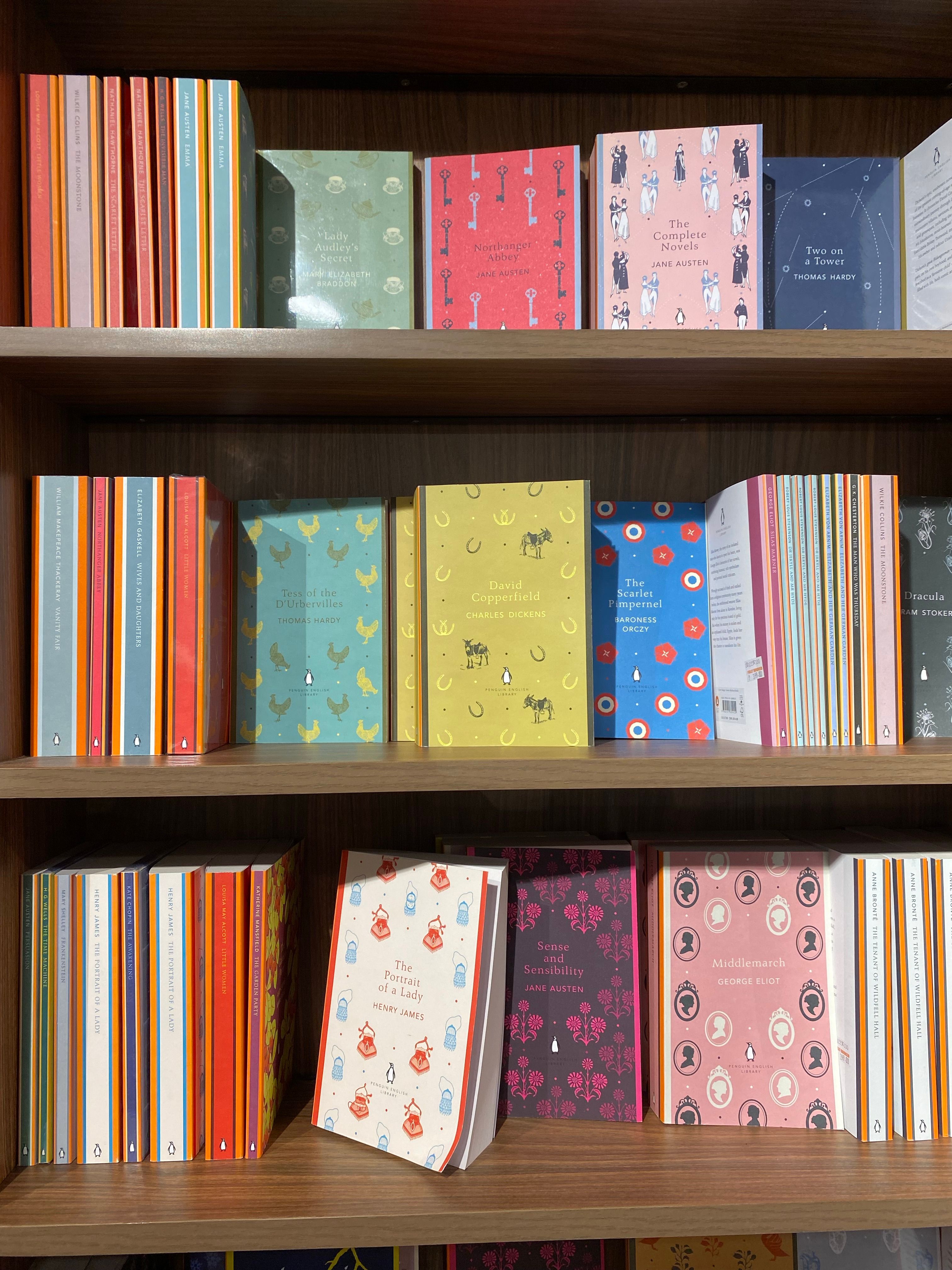 Colorful Assorted Book Covers on a Wooden Shelf · Free Stock Photo
