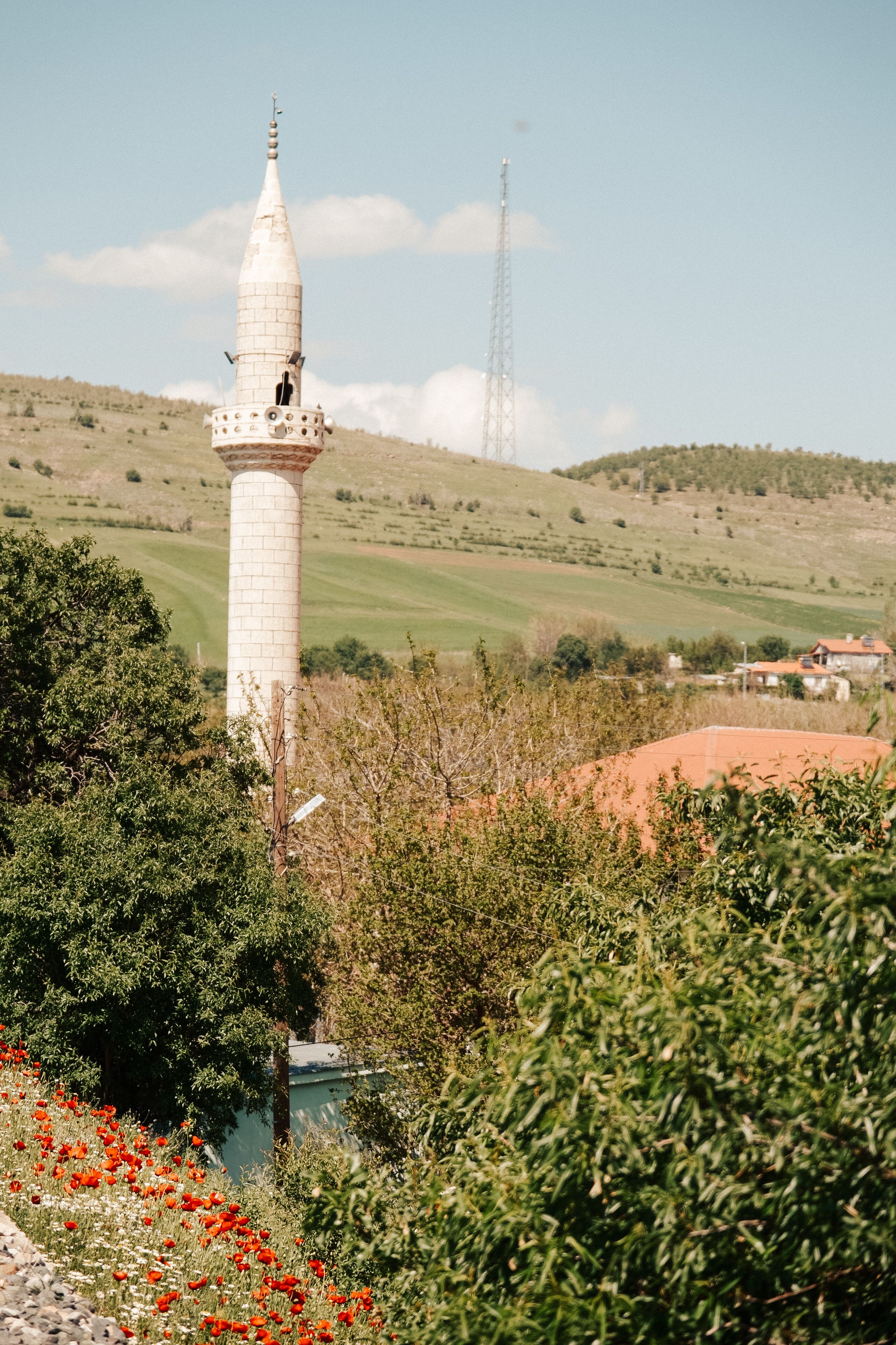 Minaret Tower Amidst Scenic Countryside Landscape · Free Stock Photo