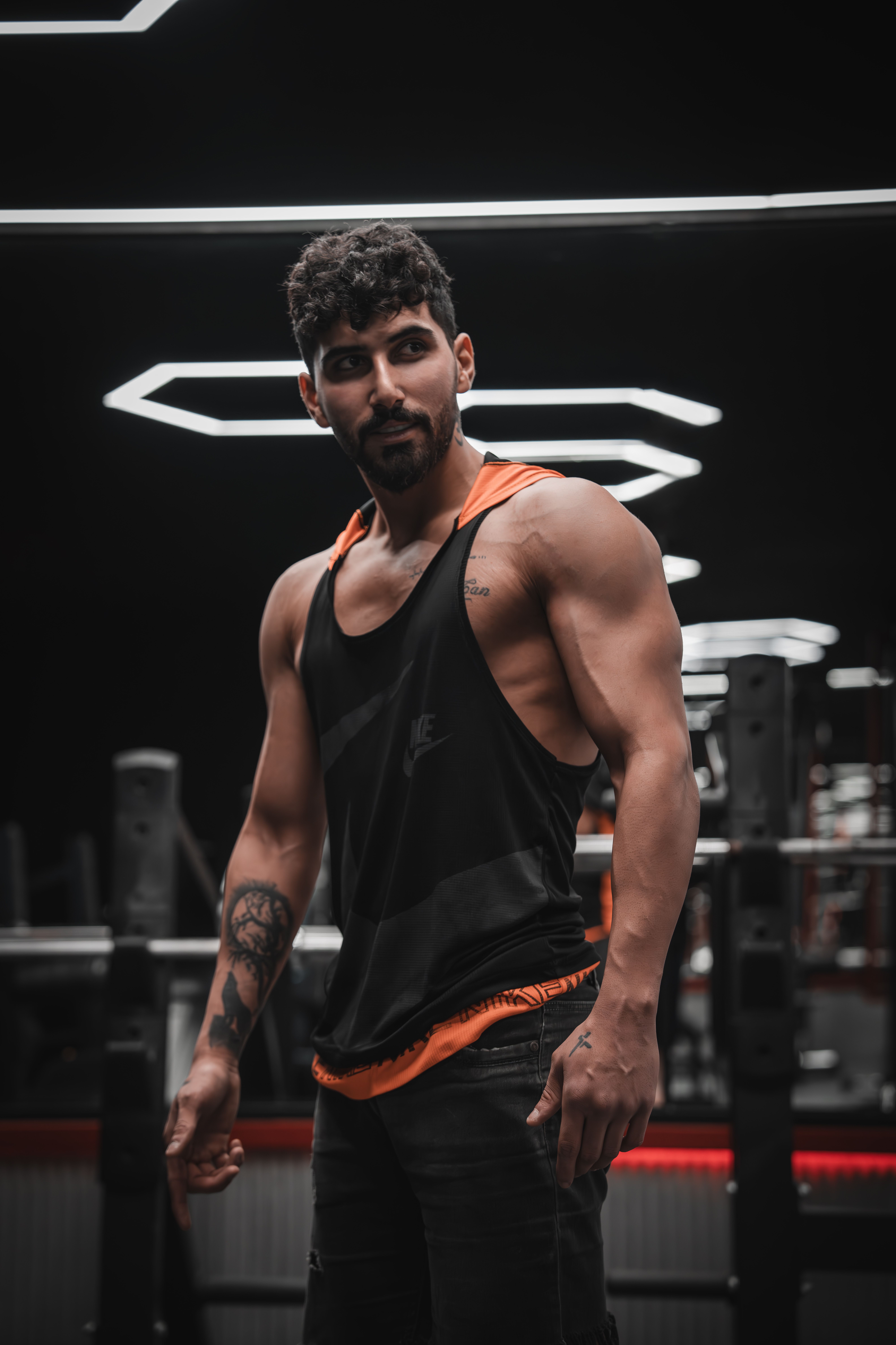 Muscular Man Posing in Modern Gym Interior · Free Stock Photo