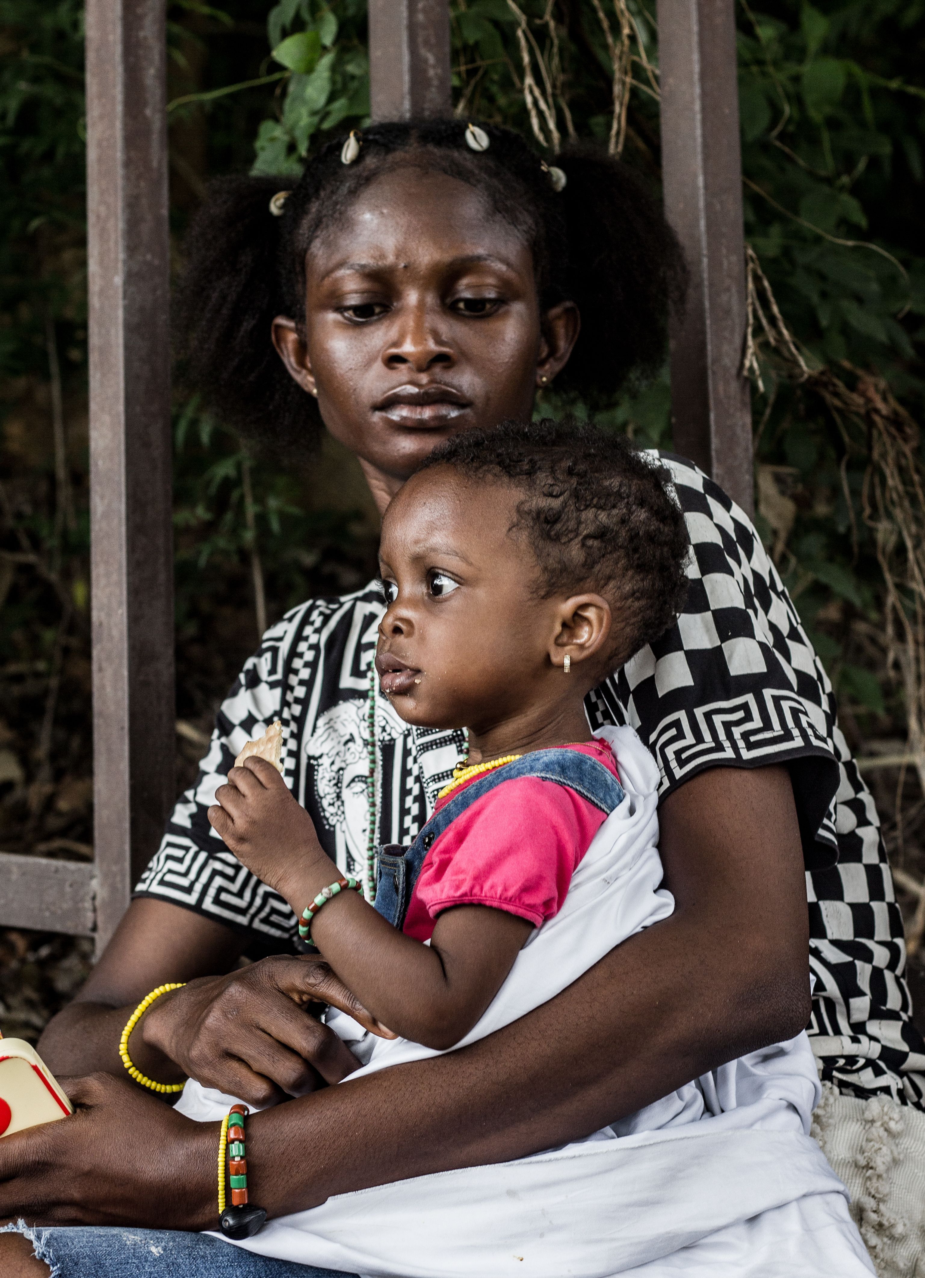Mother and Child in Thoughtful Embrace Outdoors · Free Stock Photo