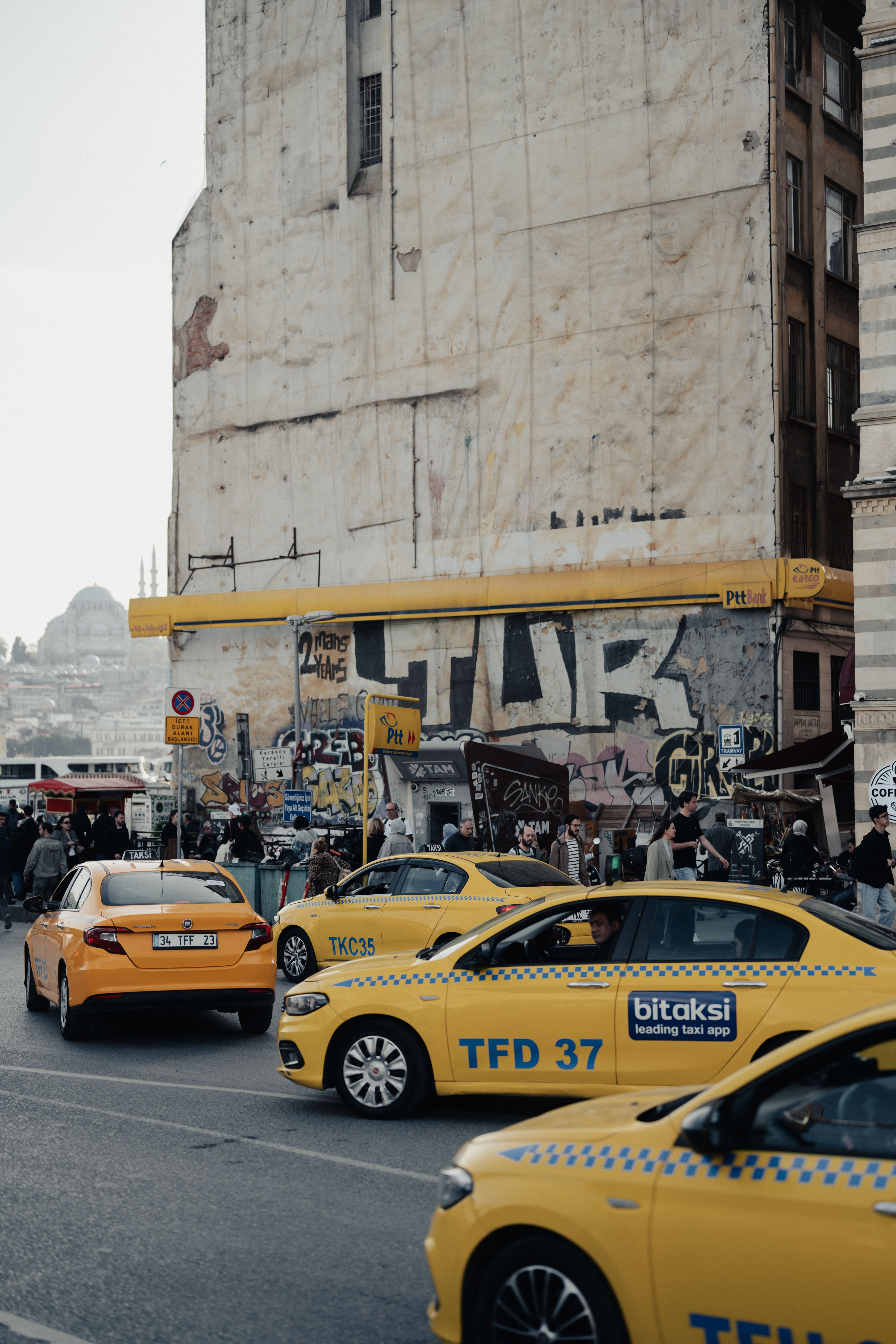 Bustling Street Scene in Istanbul with Yellow Taxis · Free Stock Photo