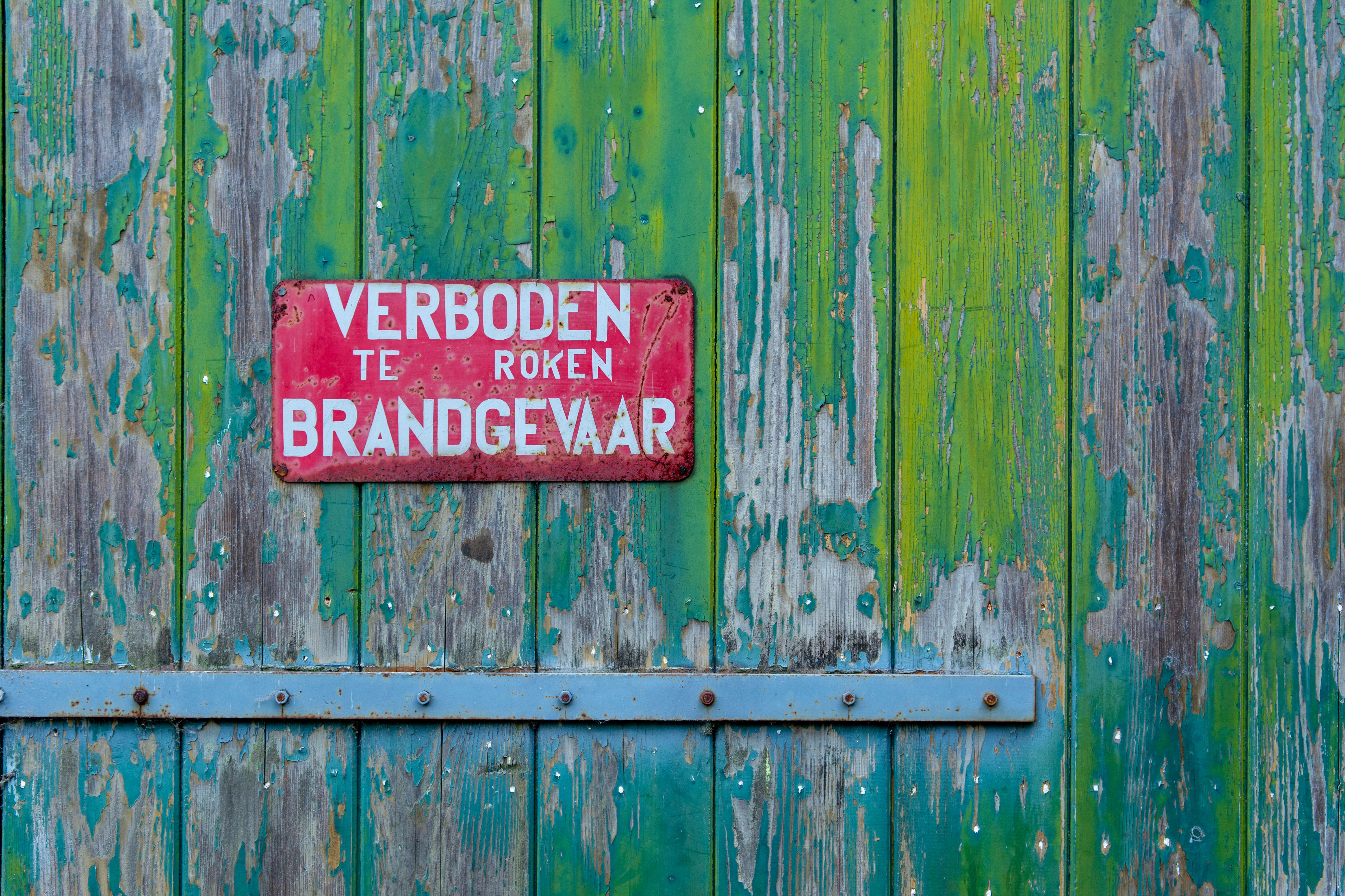 Weathered Wooden Door with Warning Sign · Free Stock Photo