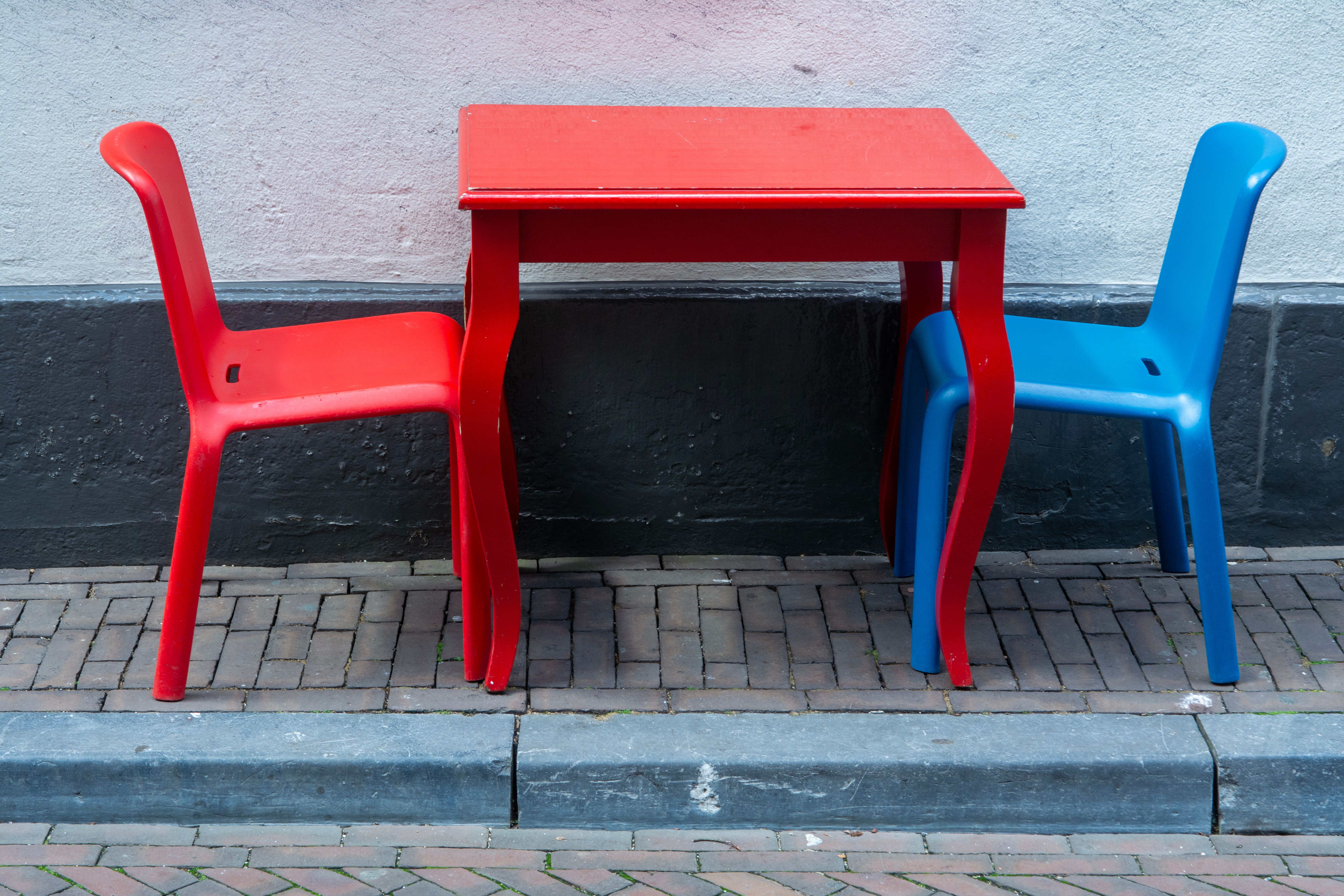 Colorful Street Setup with Red & Blue Chairs · Free Stock Photo