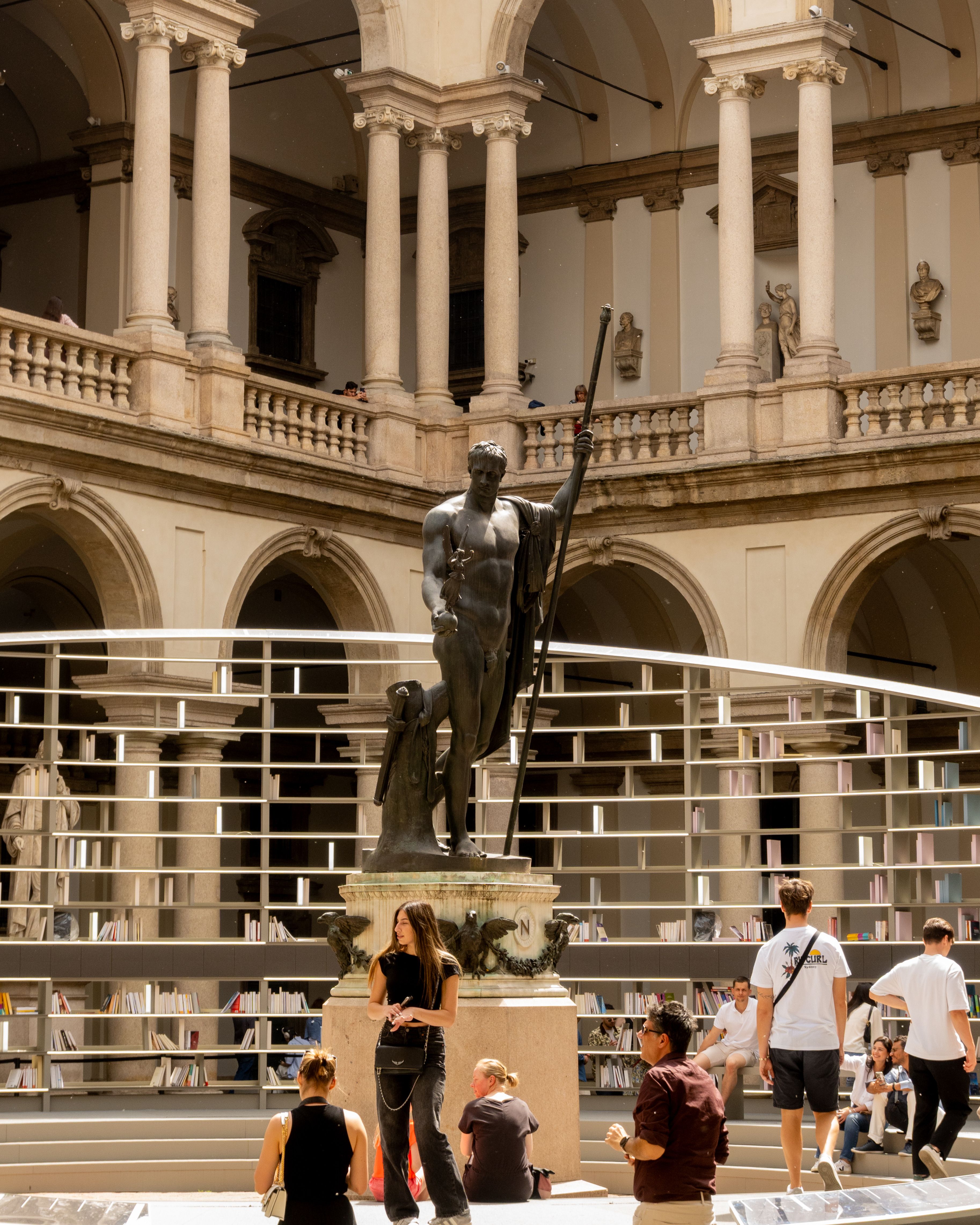 Classical Statue in Courtyard with Visitors · Free Stock Photo