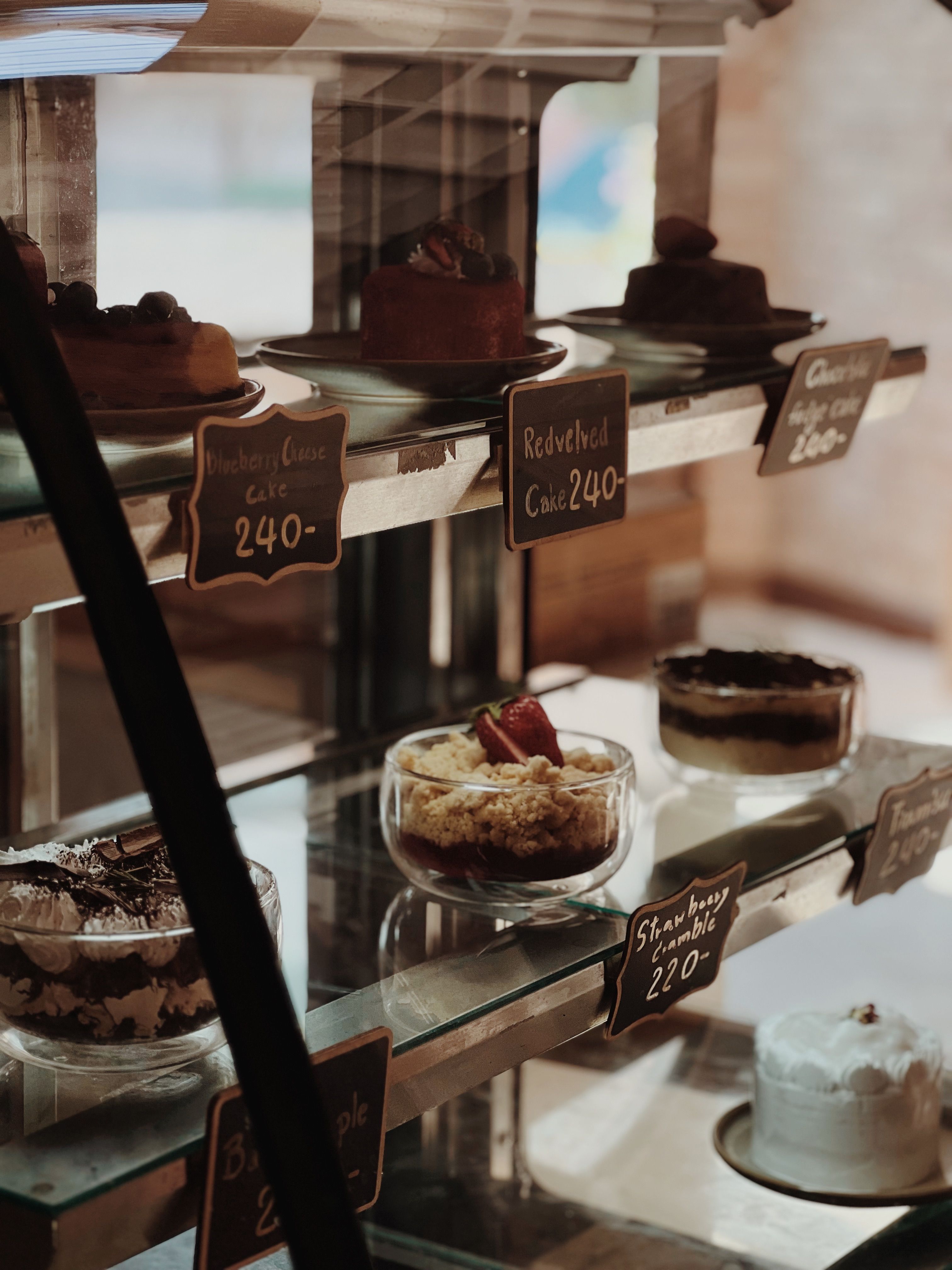 Delicious Assorted Cakes in Display Case · Free Stock Photo