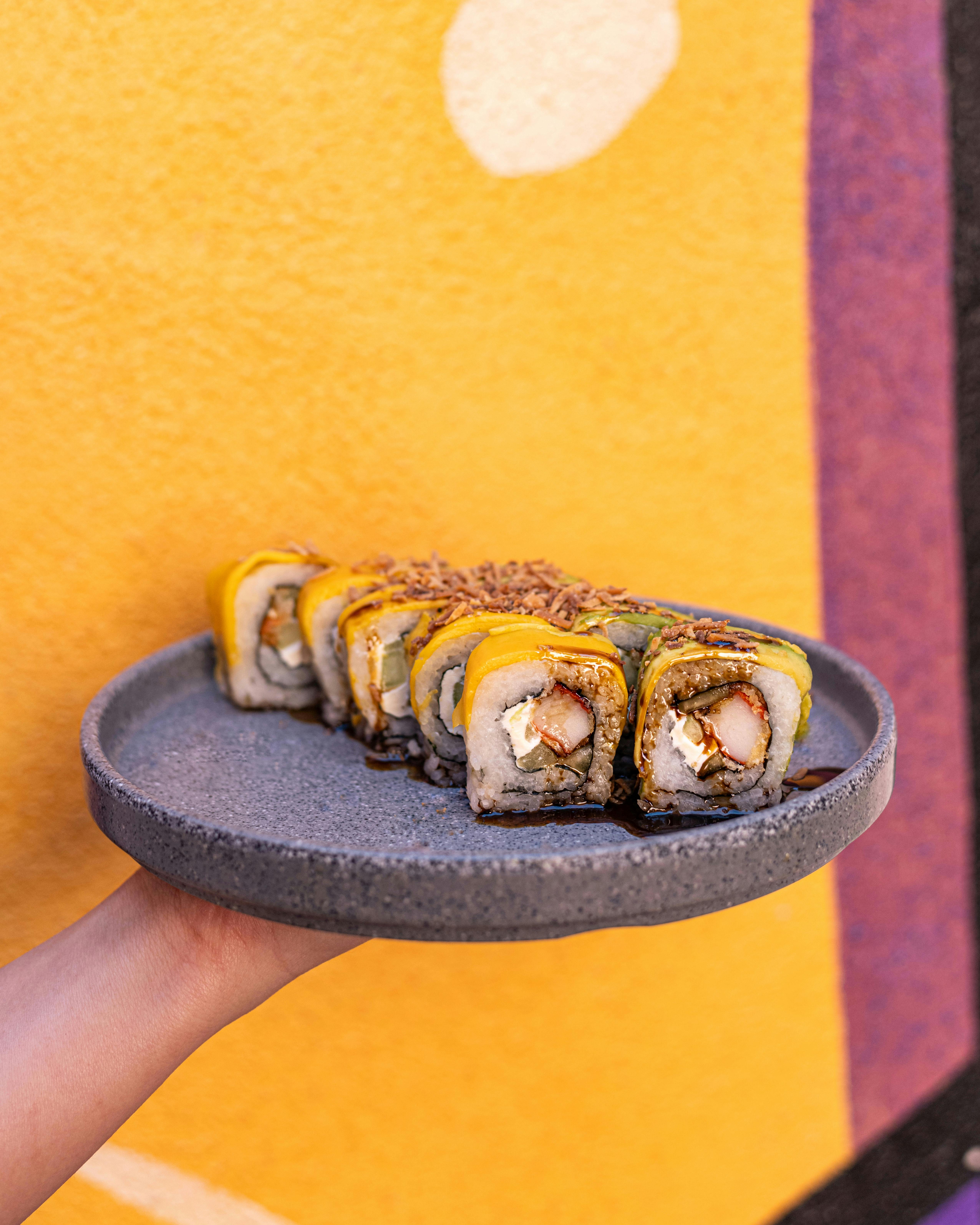 Mango Sushi Roll on Bold Art Background · Free Stock Photo