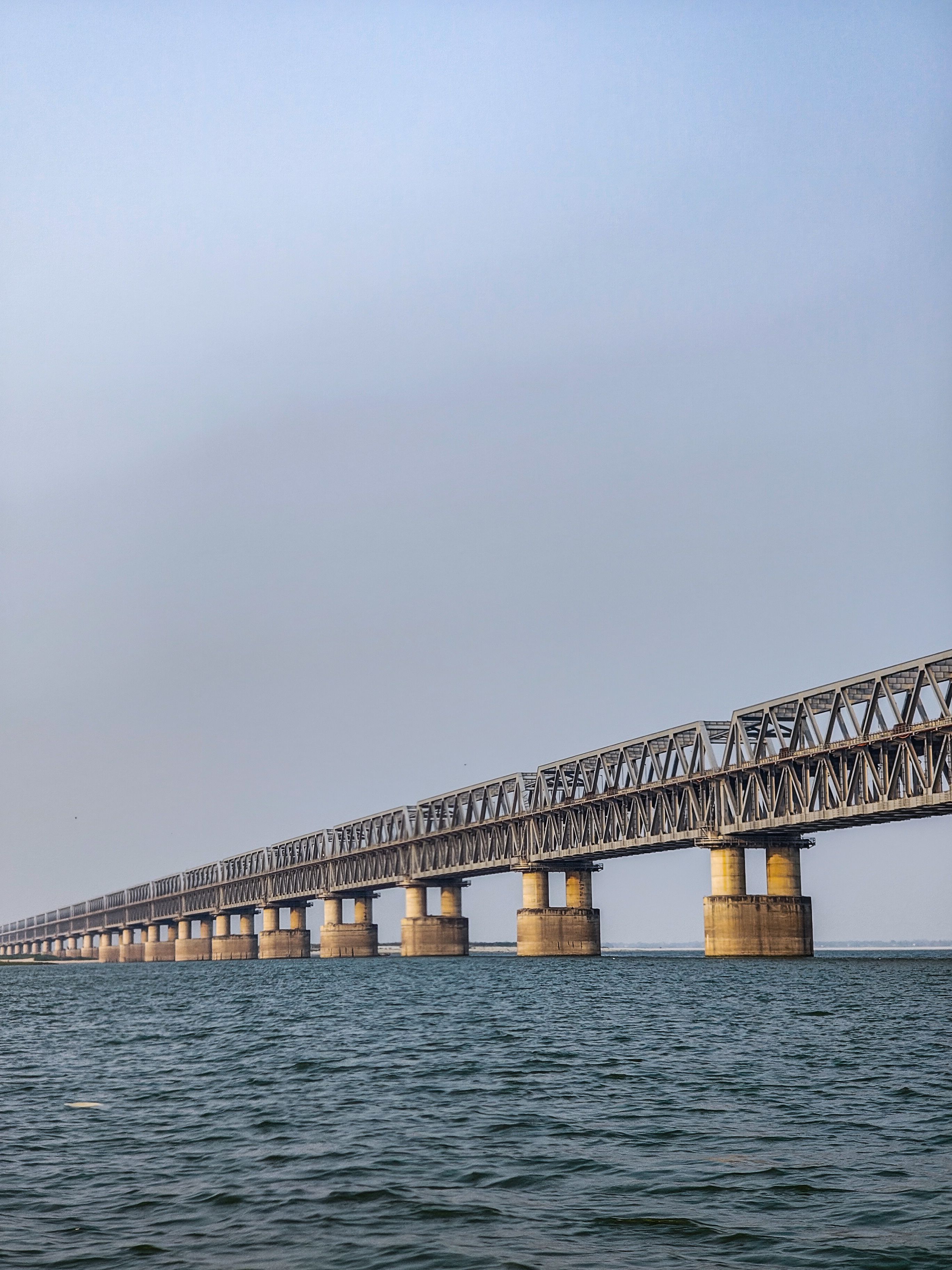 Massive Steel Bridge Spanning Over Calm Blue Water · Free Stock Photo