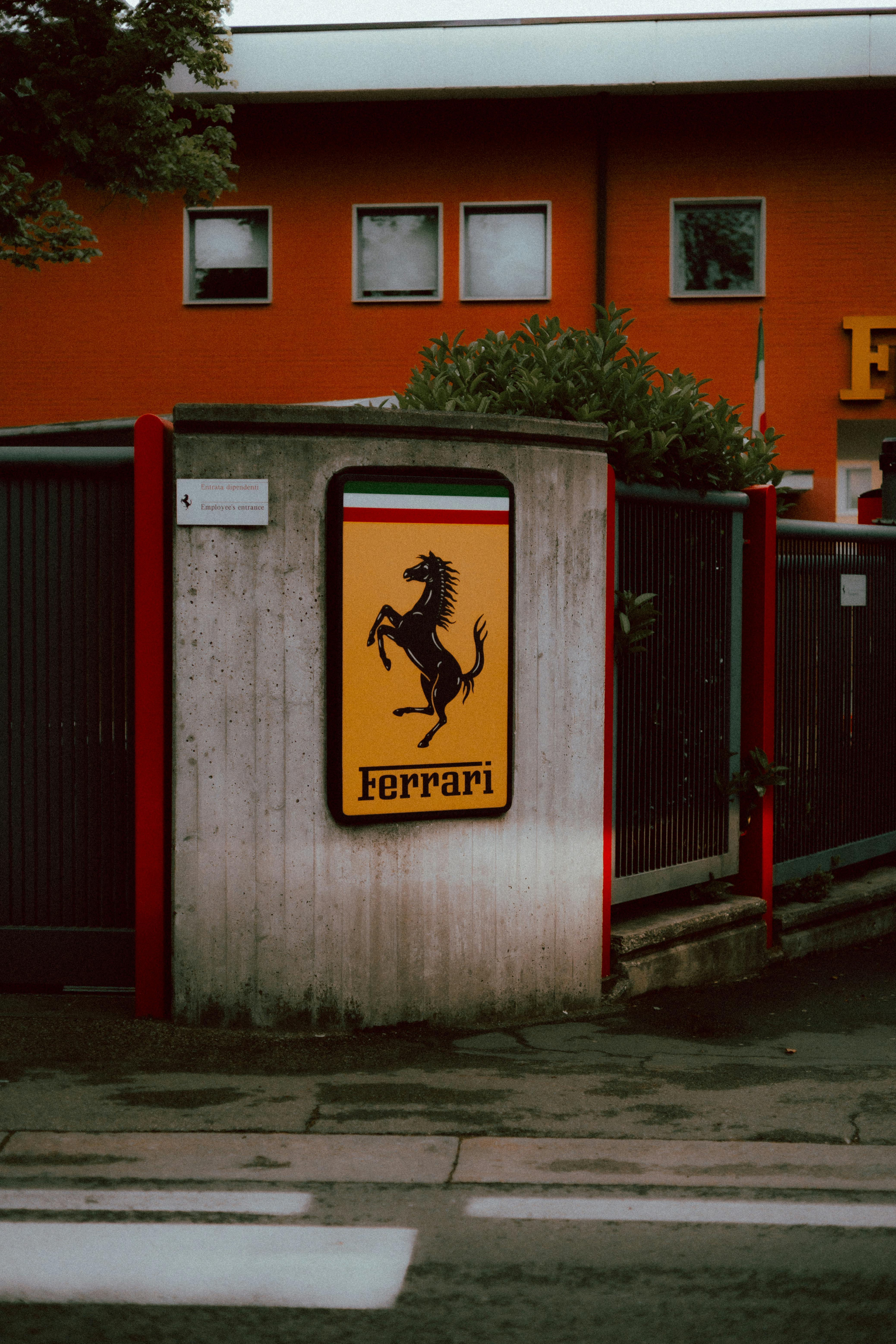 Ferrari Logo on Urban Concrete Wall Outdoors · Free Stock Photo