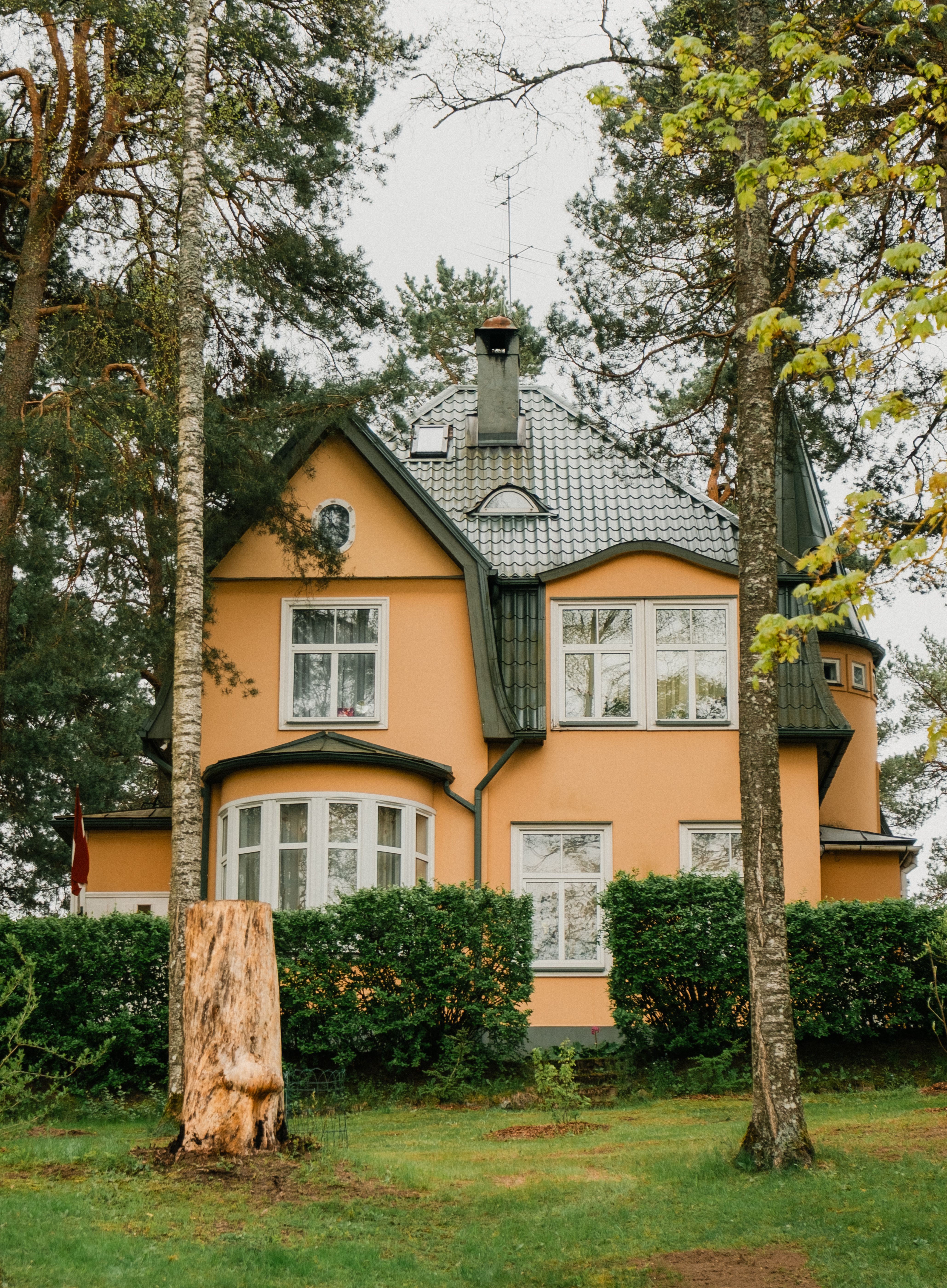 Charming Yellow House Amidst Lush Trees · Free Stock Photo